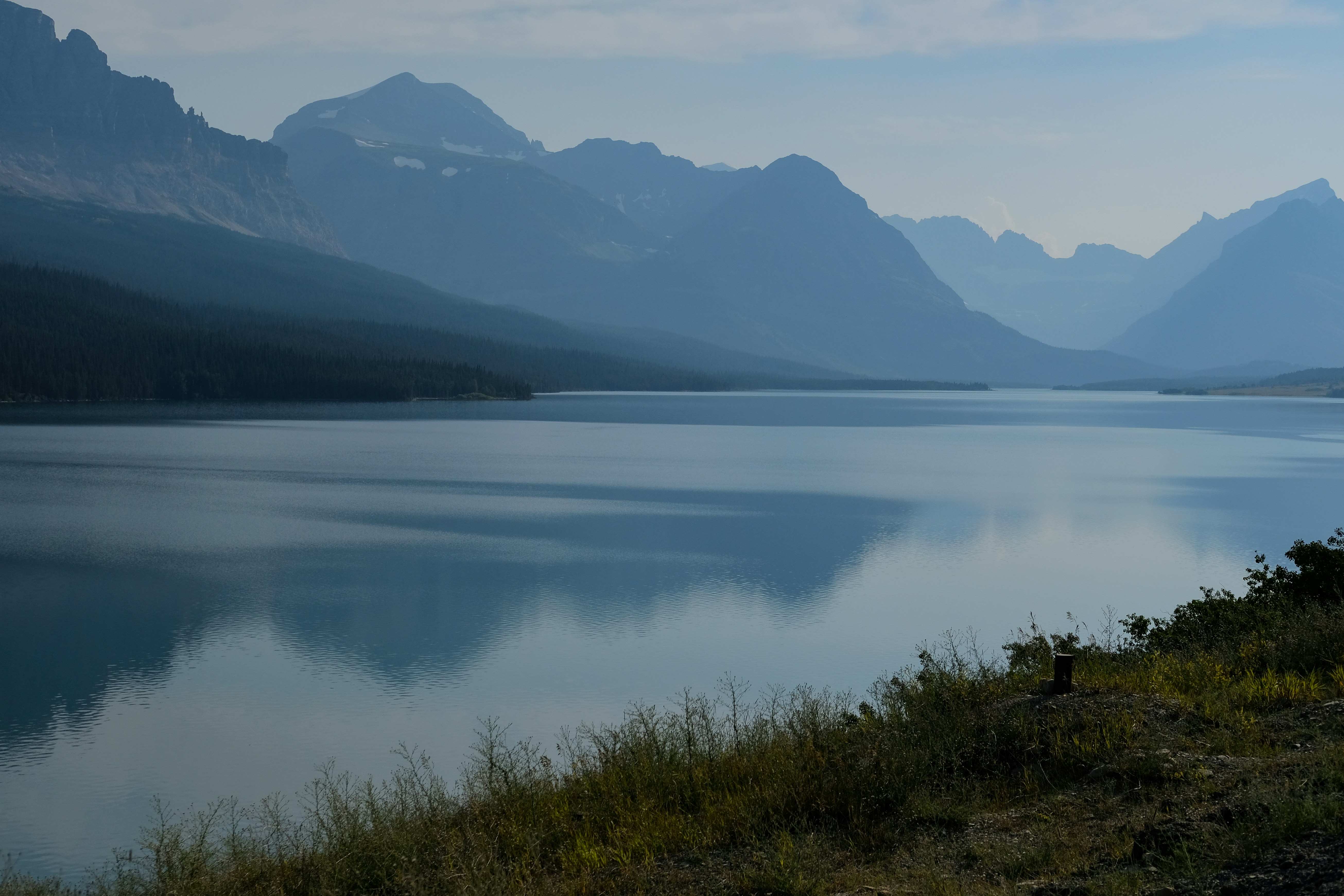 Horizon Echoes: Reflected Peaks on a Glassy Alpine Lake