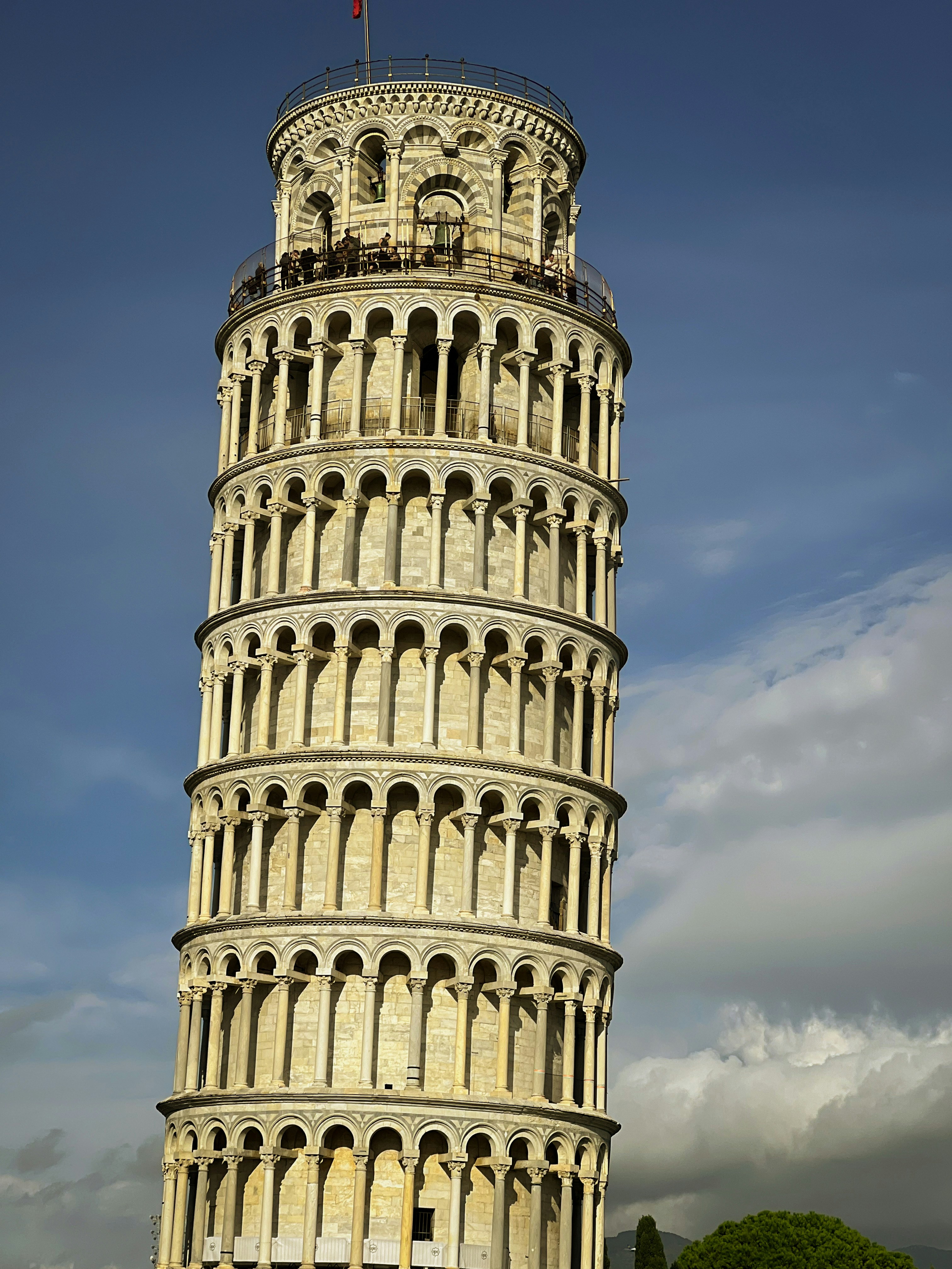Tiered Gravity: The Leaning Tower of Pisa Against a Crisp Blue Sky