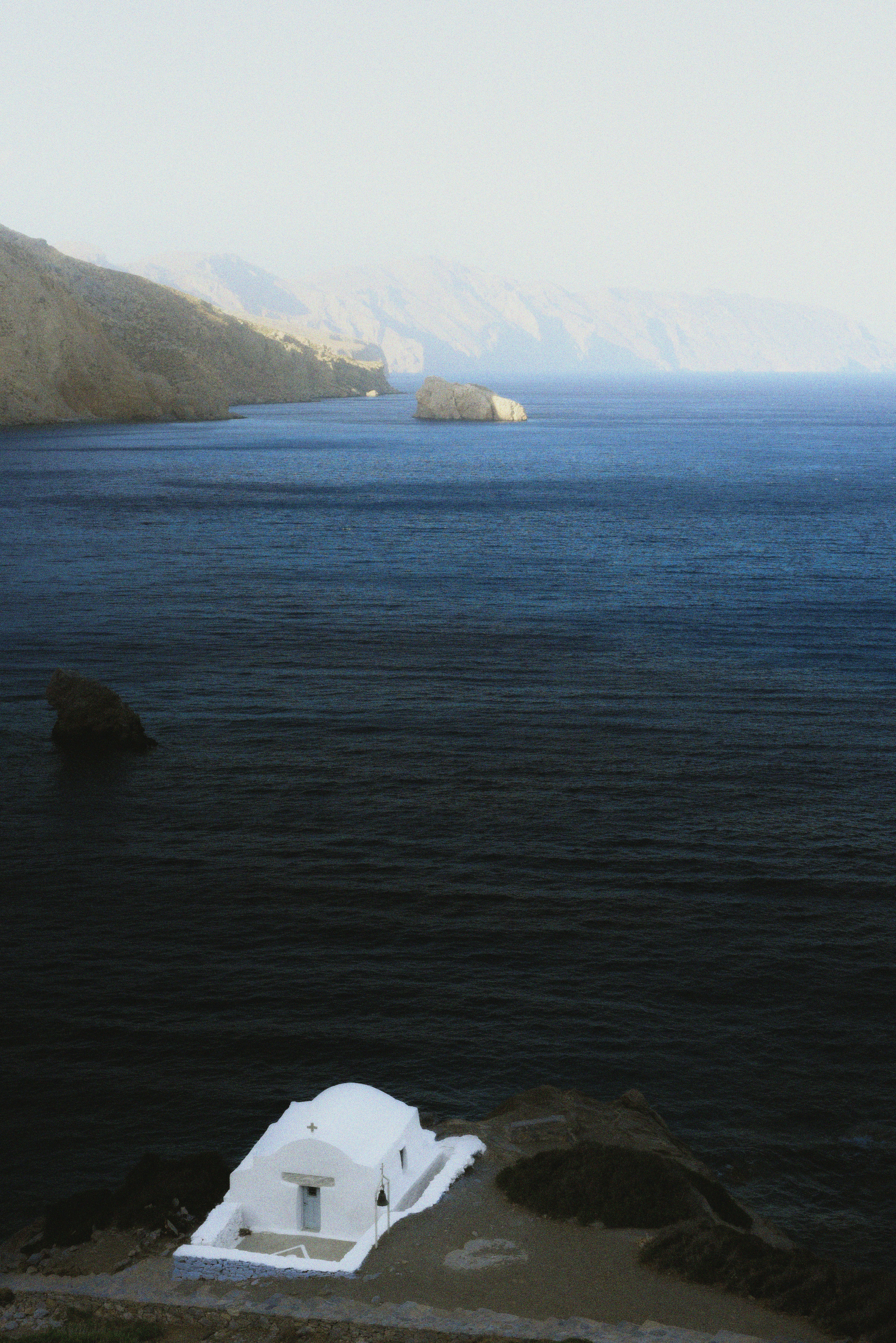 White Chapel at the Edge of the Aegean Blue