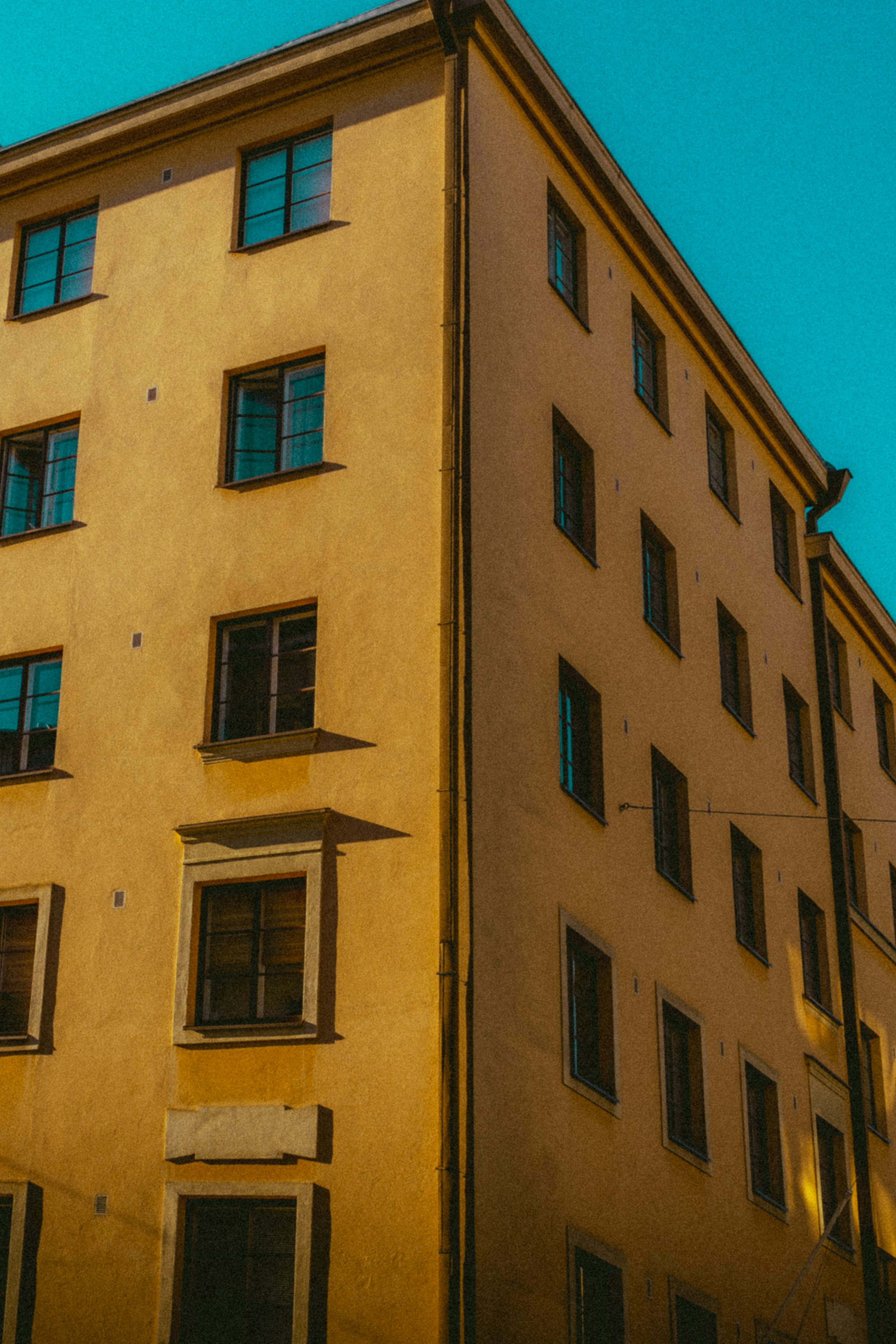 A tall yellow building with lots of windows photo – Free Töölö Image on ...