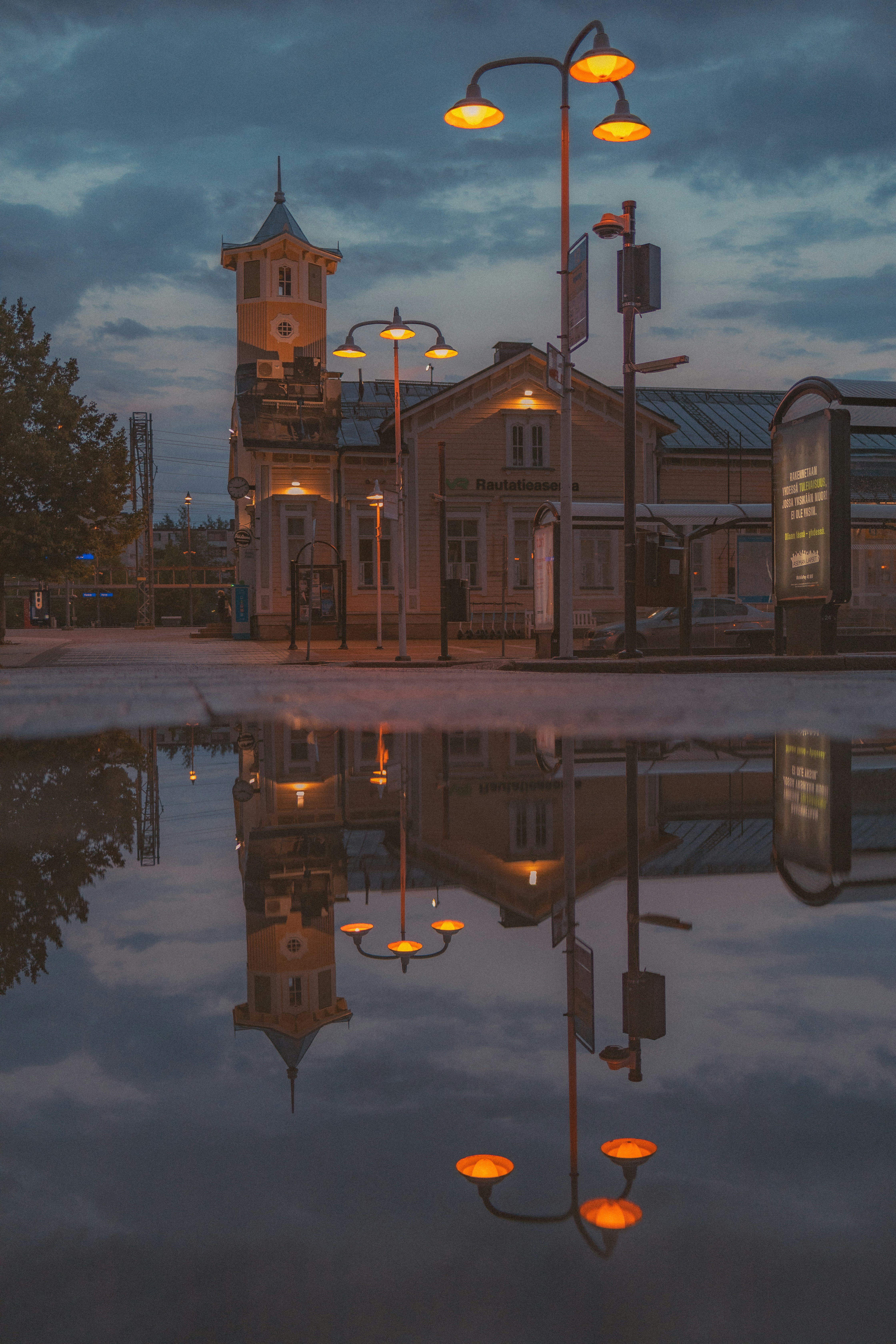 A reflection of a clock tower in a puddle of water photo – Free Kerava ...