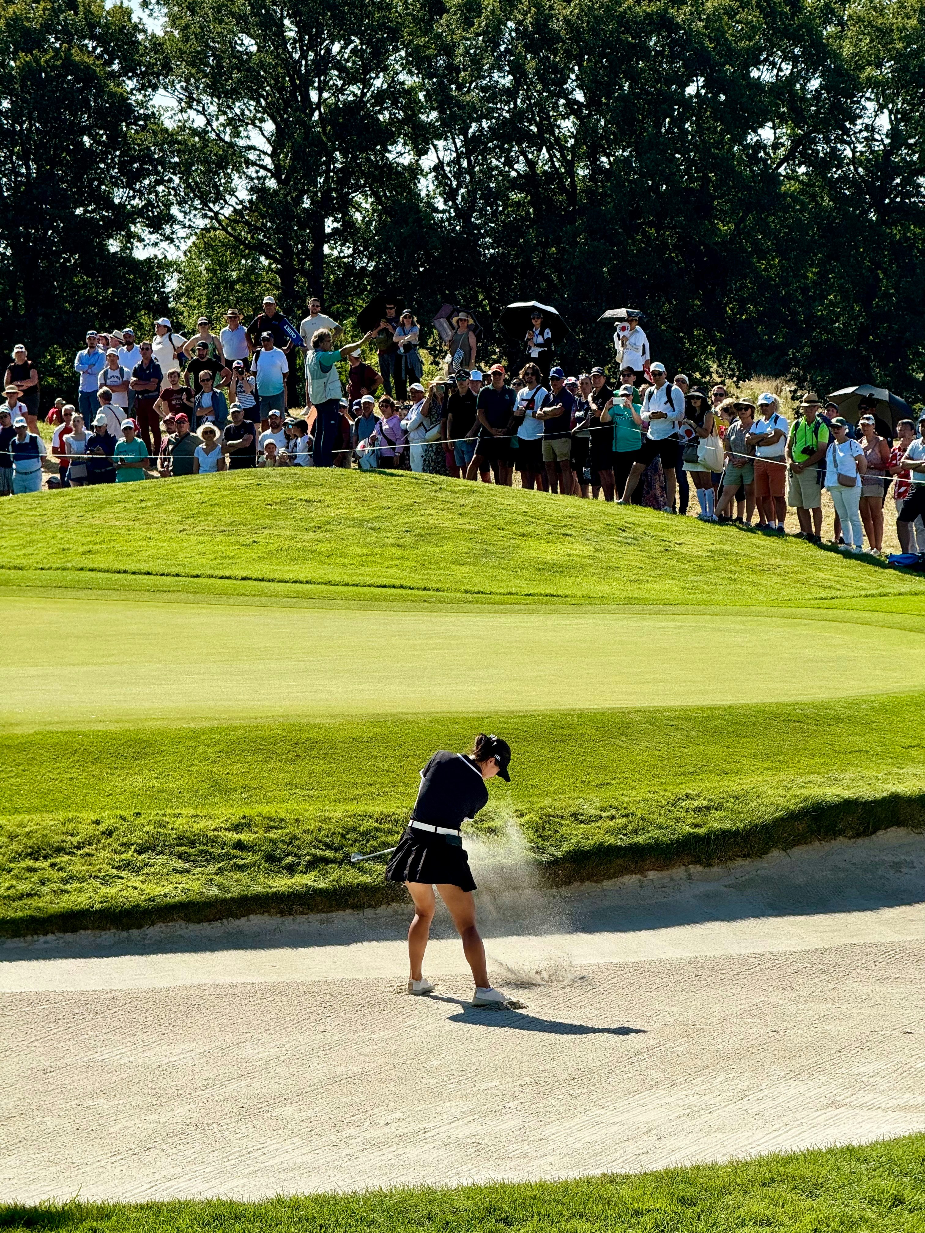 Sand Spray at the Bunker: A Golf Shot Draws the Crowd