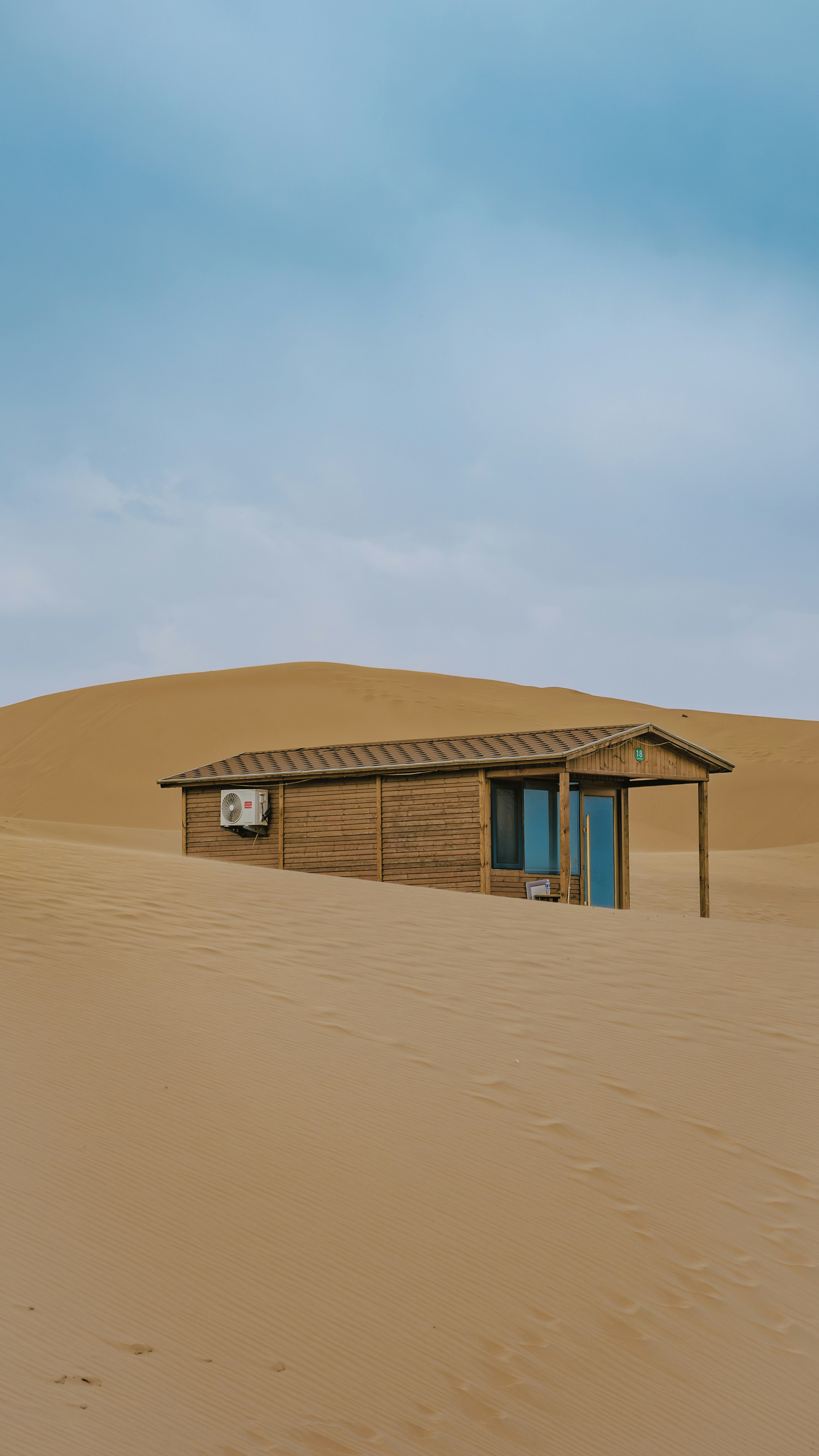Duneside Cabin: Weathered Wood Beneath a Wide Desert Sky