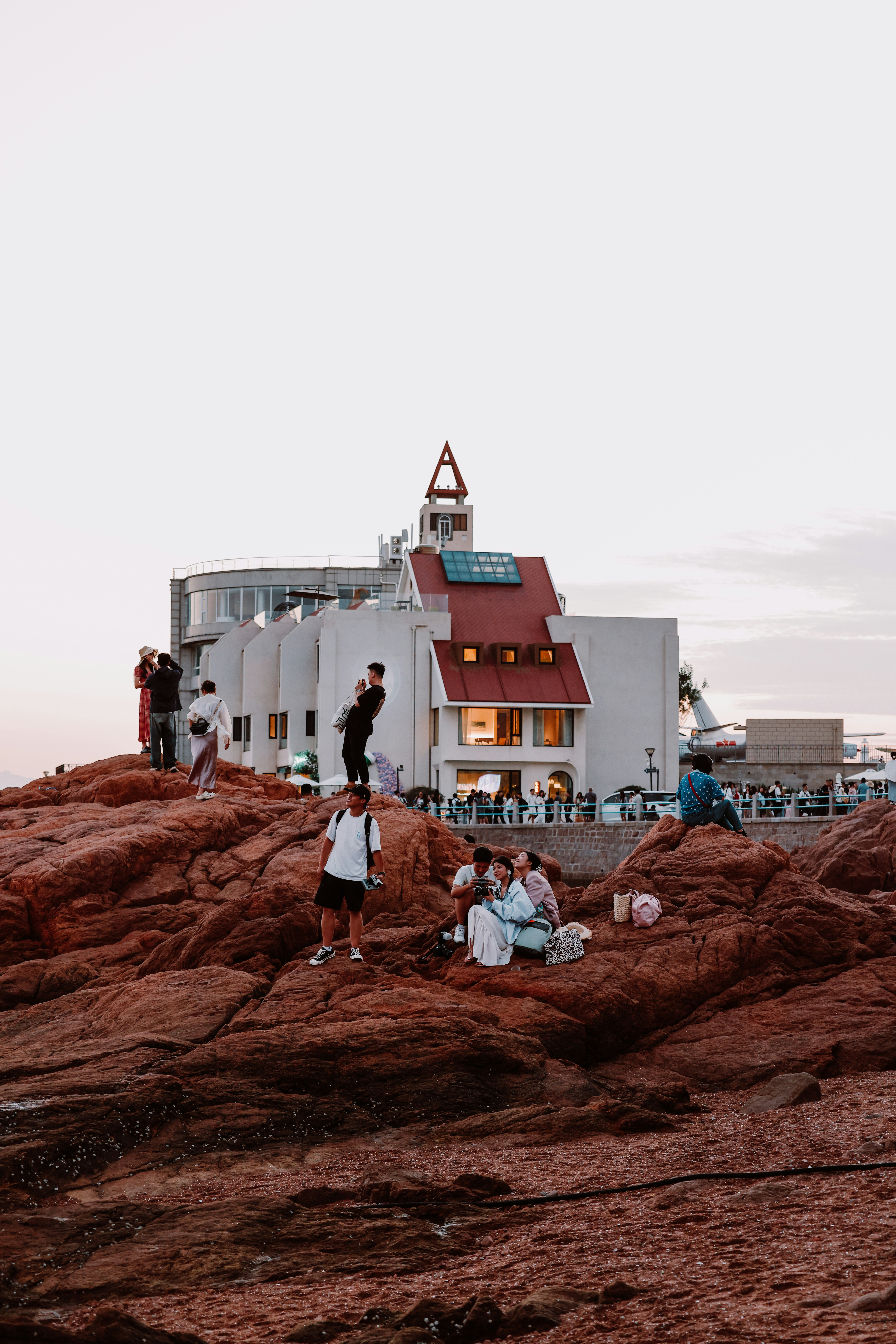 A group of people standing on top of a rocky cliff photo – Free Qingdao ...