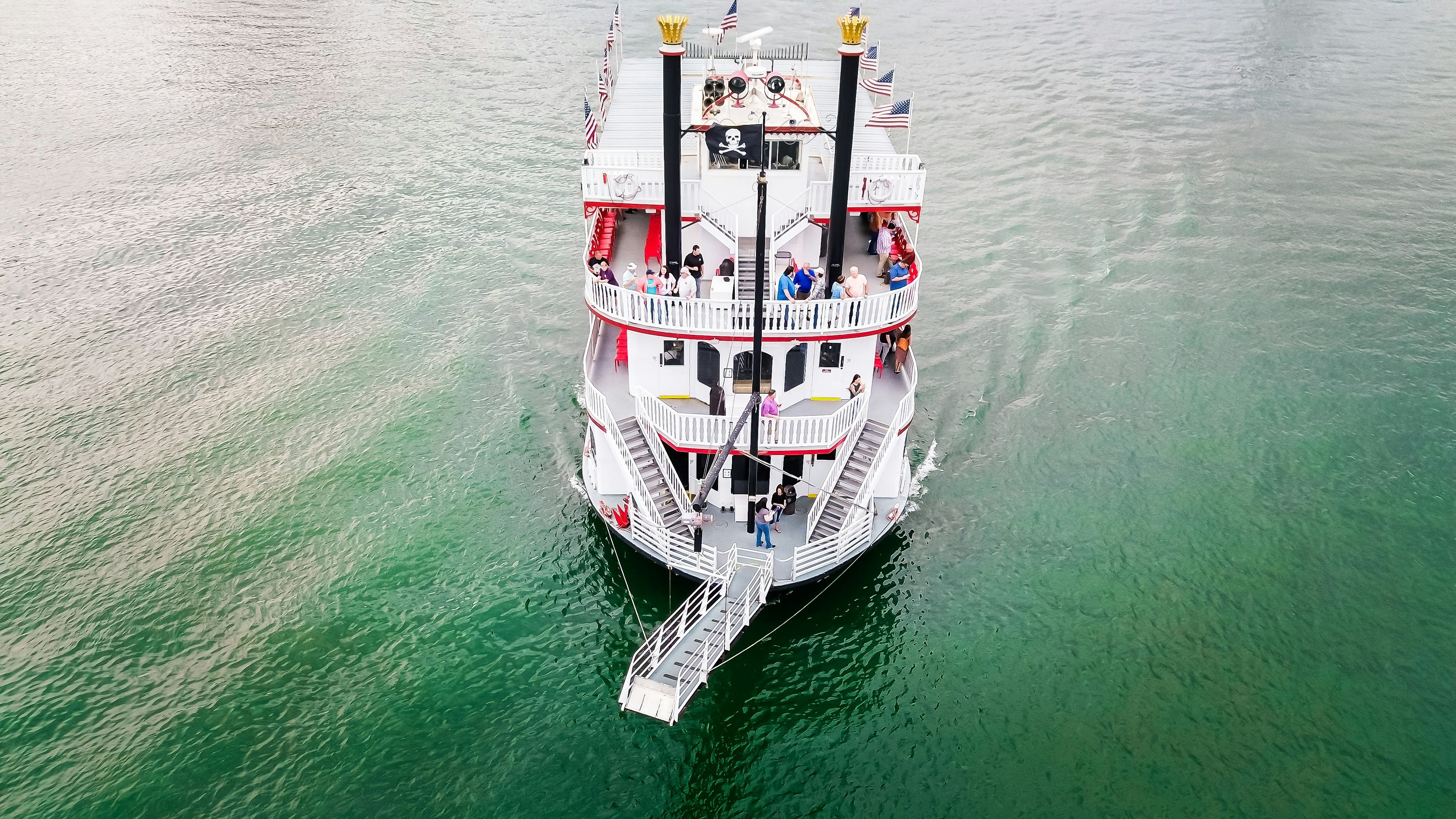 Decked in Red, Afloat: A Drone View of a White Passenger Vessel