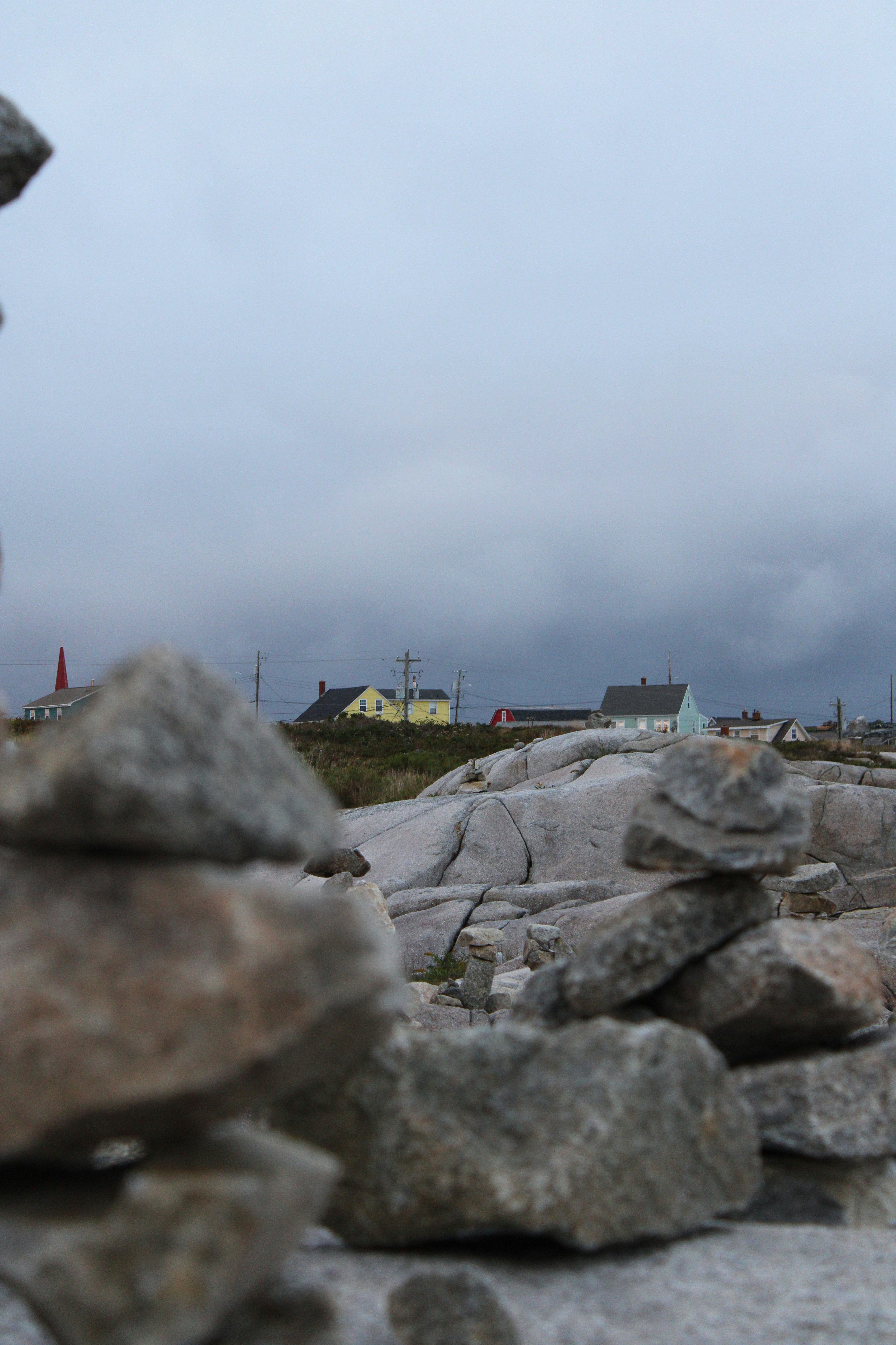 Stone Border, Quiet Horizon: A Coastal Village Under Overcast Light
