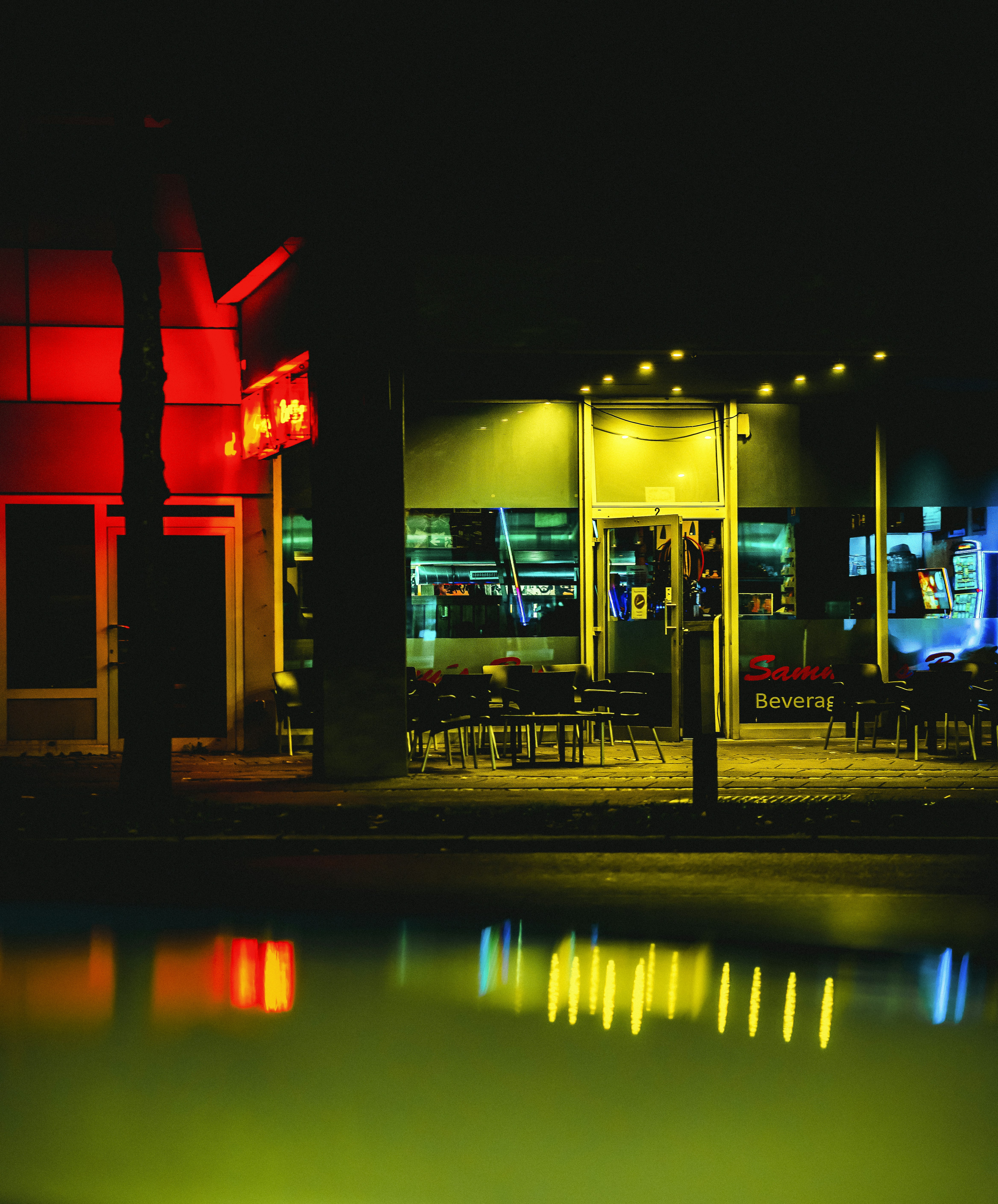 A lit up building next to a body of water photo – Free Bremen Image on ...