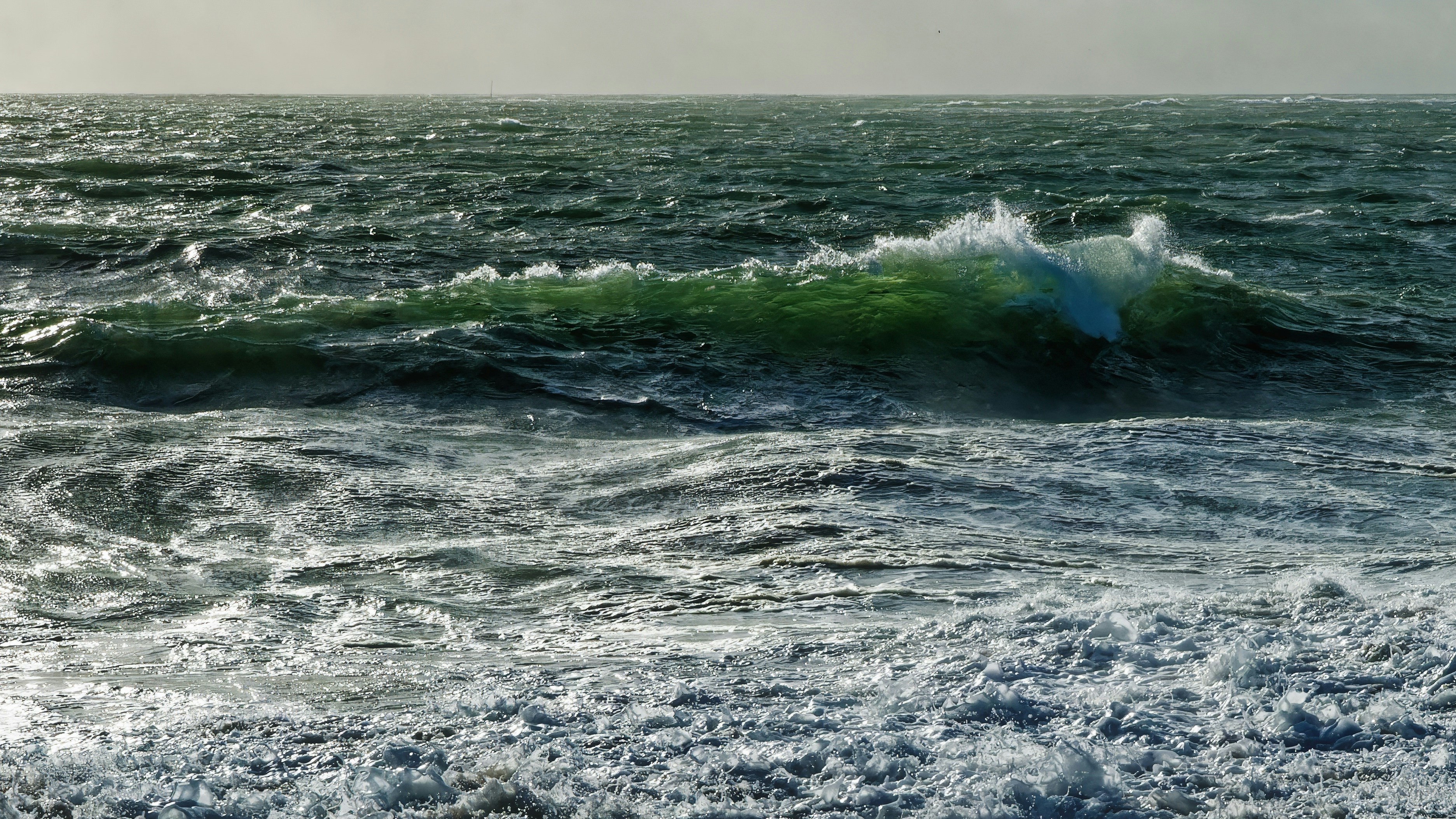Green Crest Over White Foam: A Tide's Moment of Lift