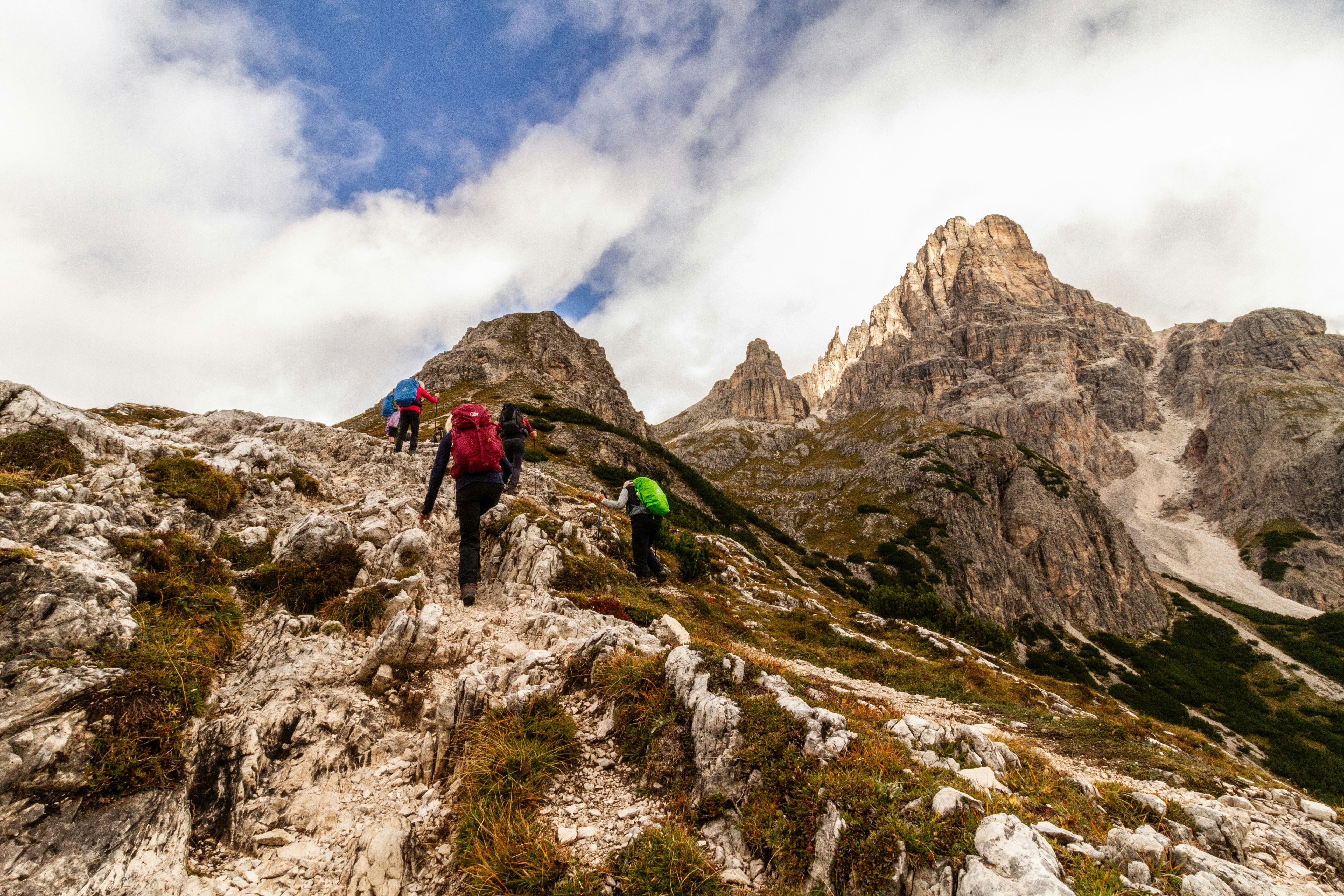 A group of people hiking up the side of a mountain photo – Free Human ...
