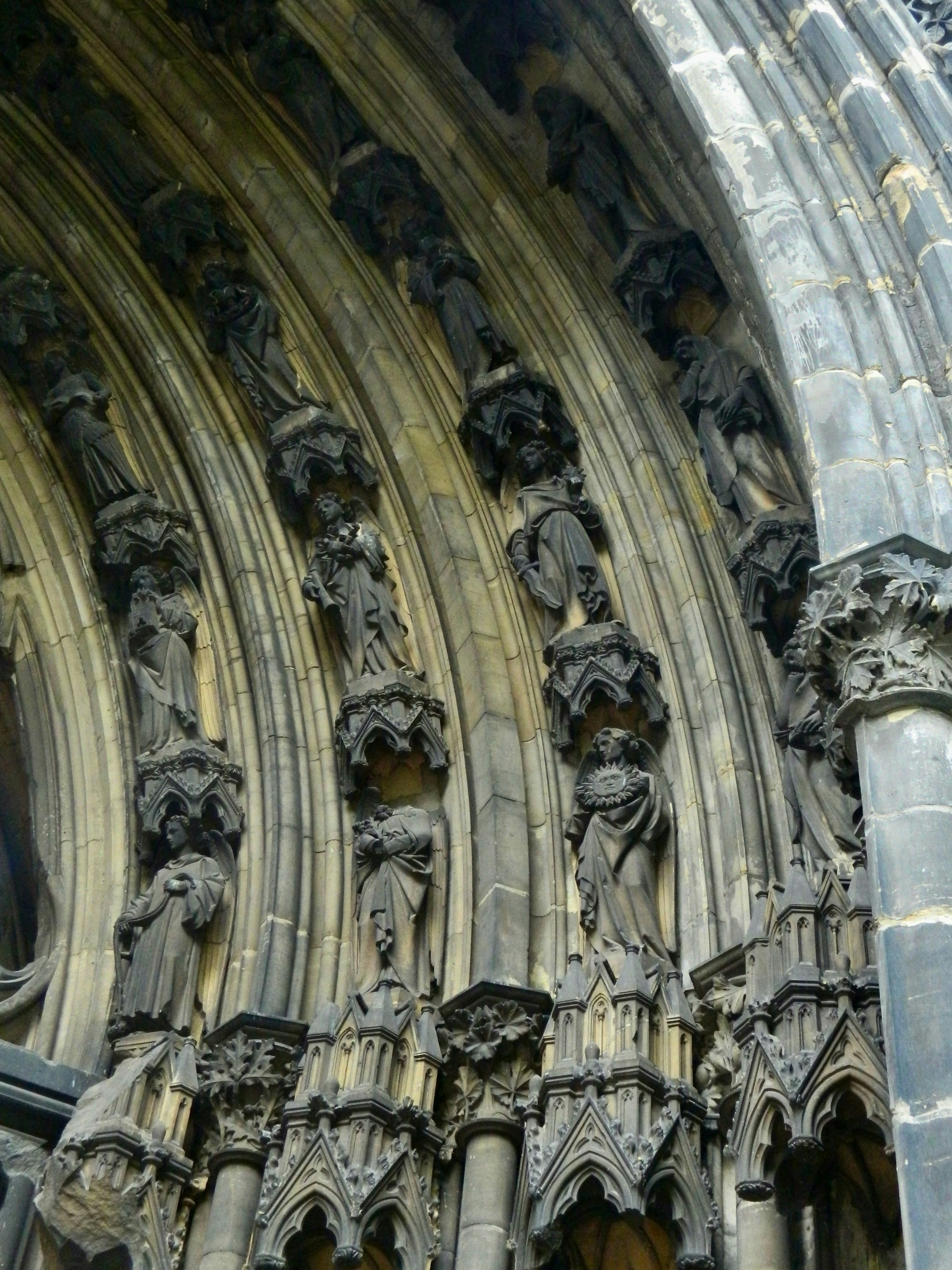 A close up of a very tall building with statues on it photo – Free ...