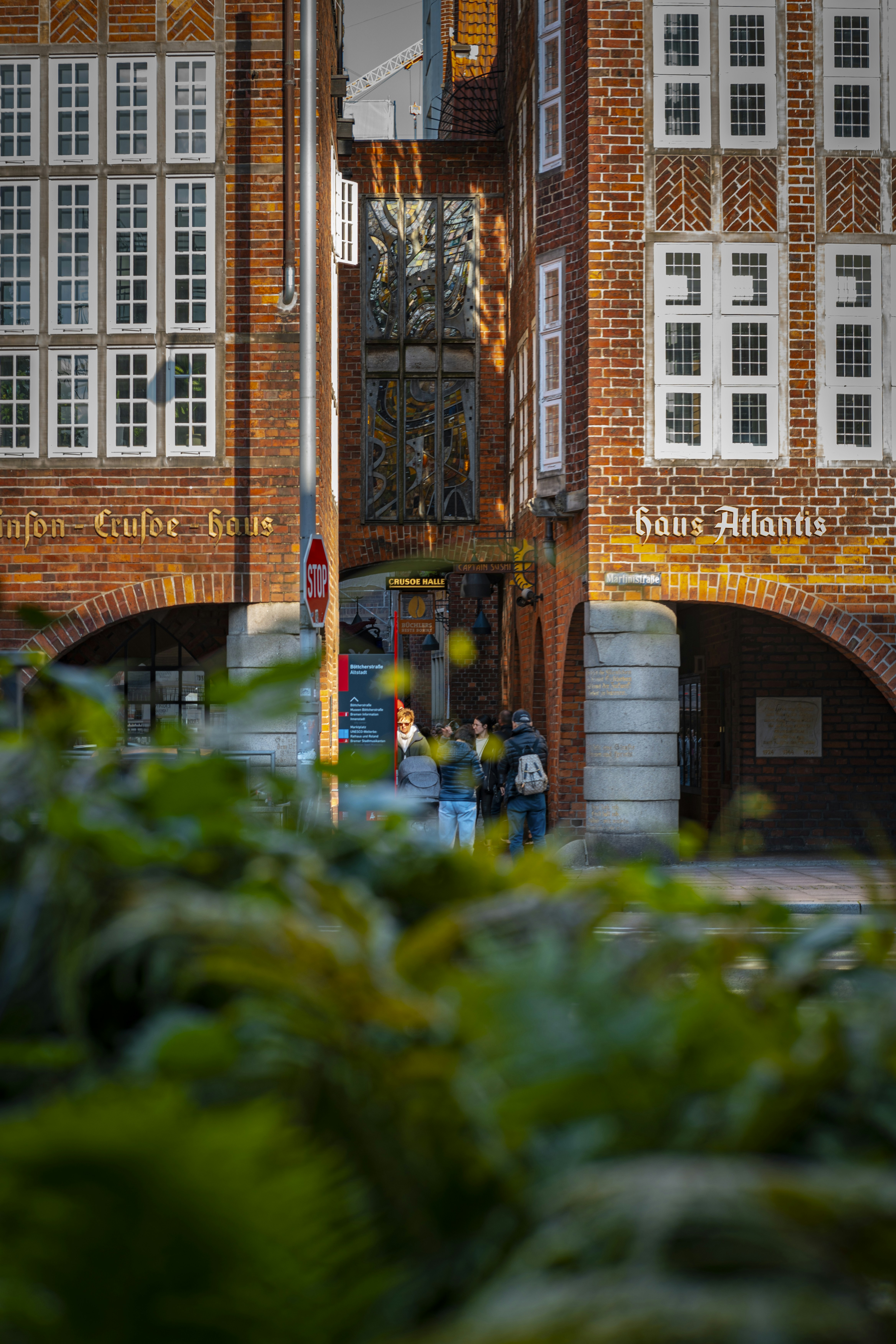 Gateway Between Brick Facades: Entrance Courtyard by Haus Atlantis