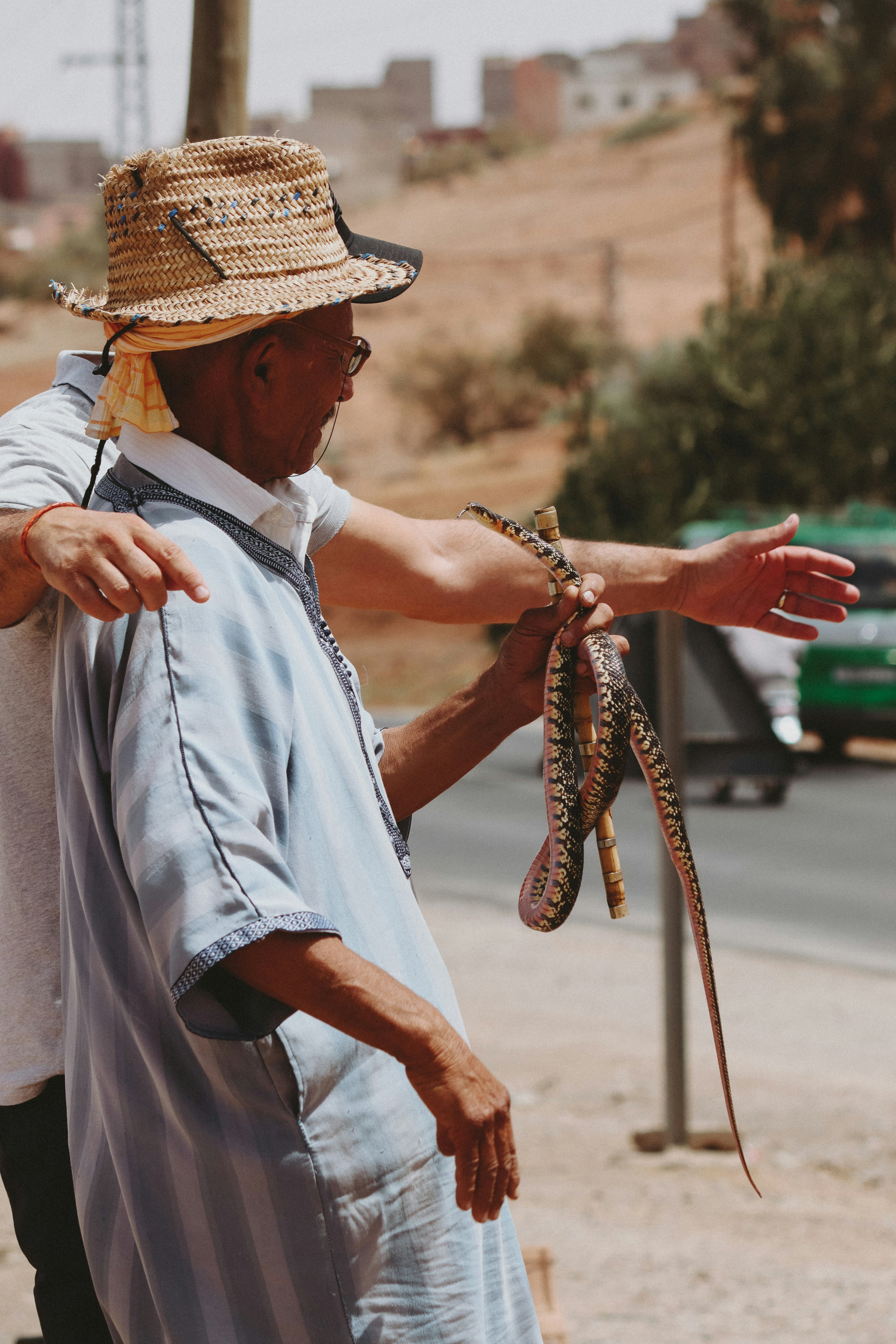 String of Time: A Street Entertainer Shows His Snakes and Sprawl