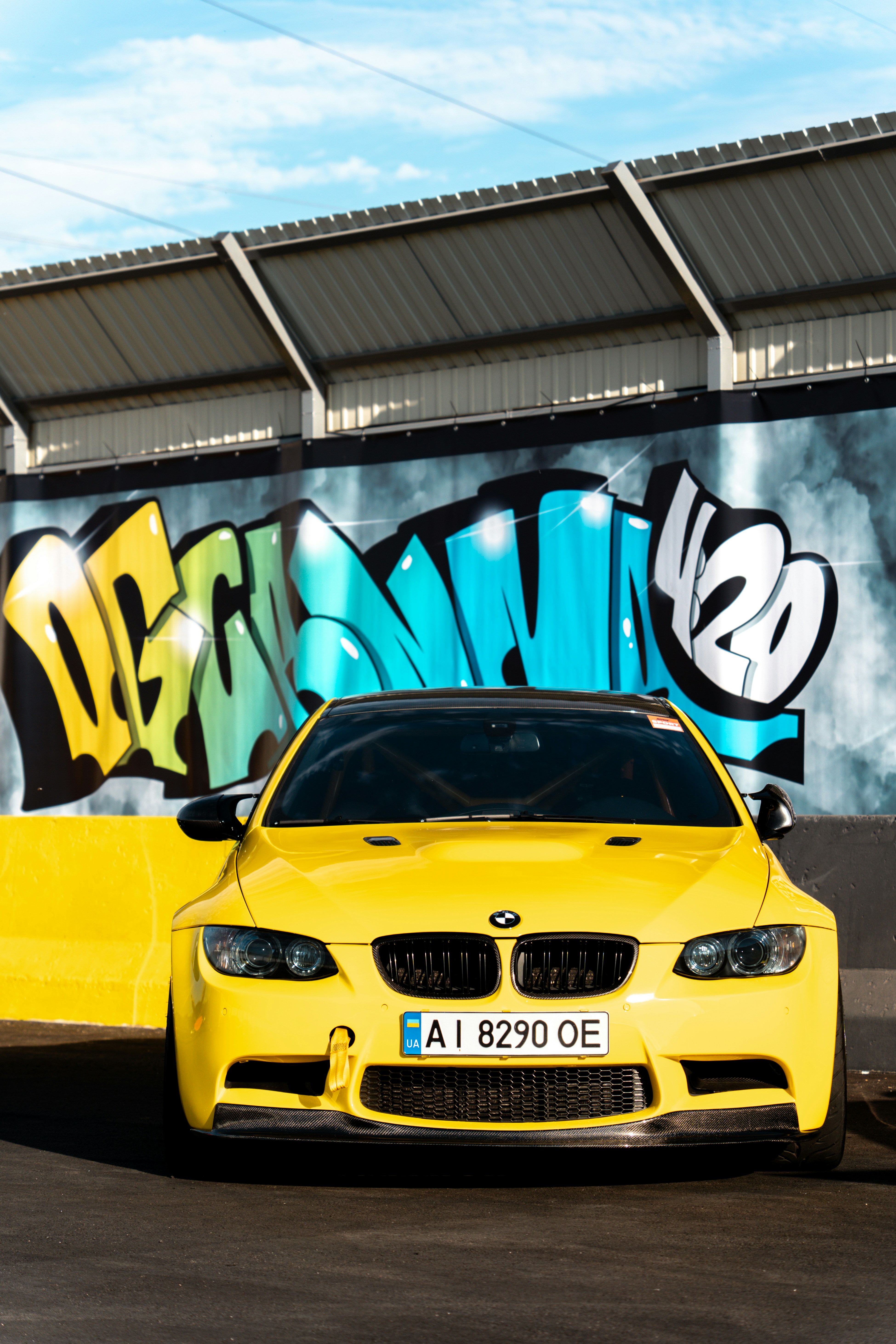 Sunlit Yellow BMW Brawler Under Graffiti Skies