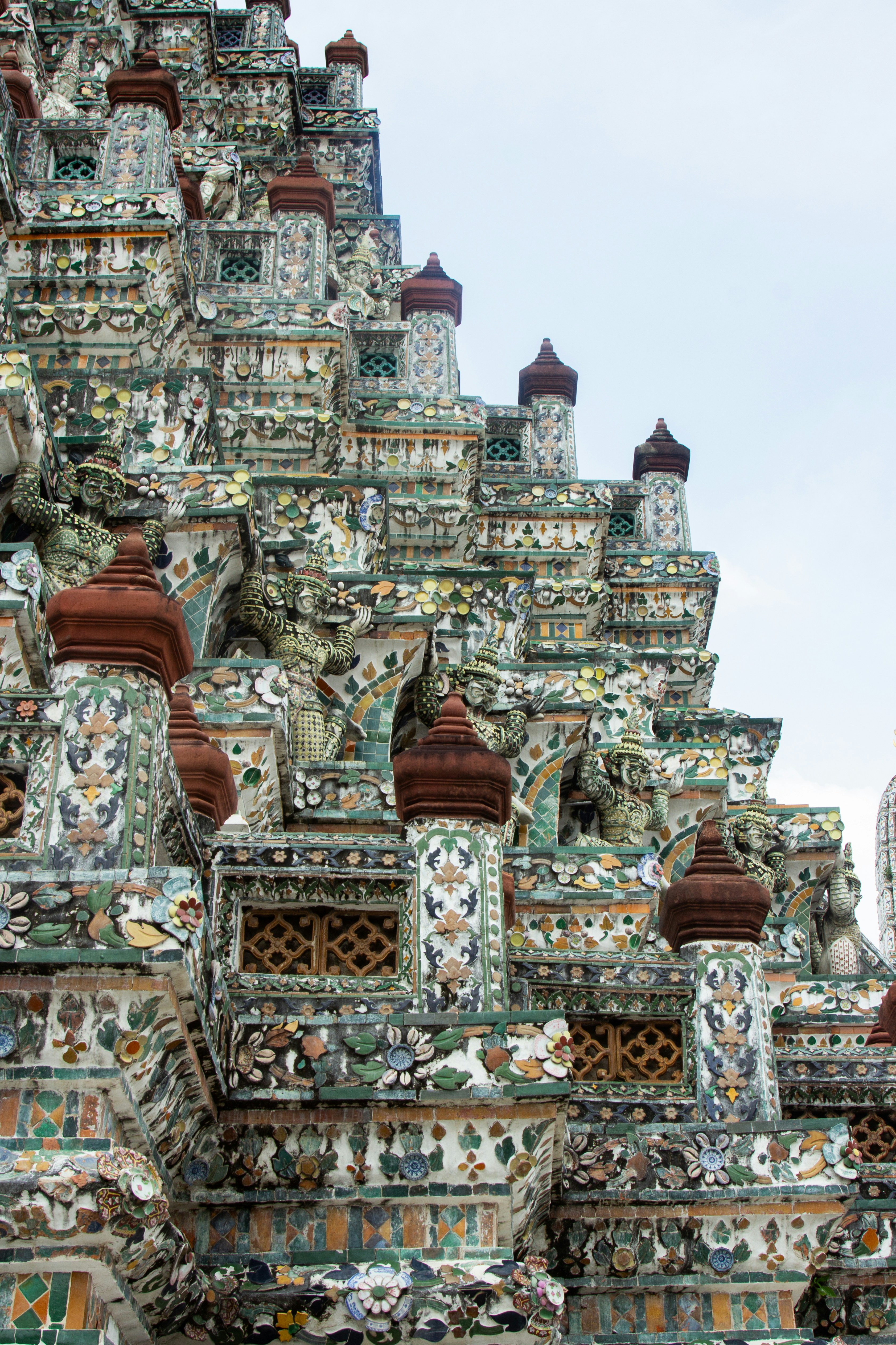 Terraced Mosaic Spire: Dragon-Guarded Facade of Porcelain Tiles