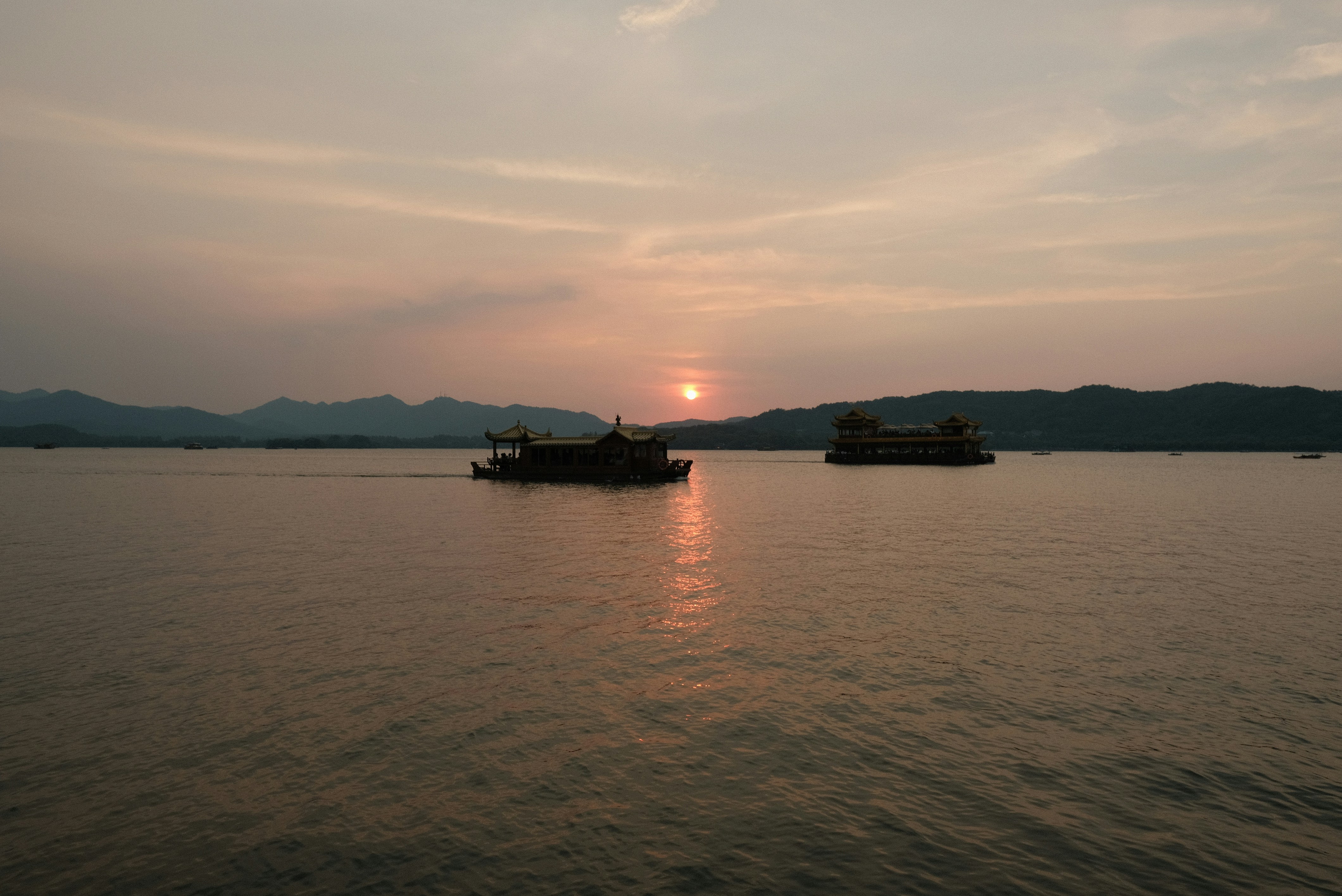 Horizon of Quiet: Two Boats at Dusk on a Glassy Sea