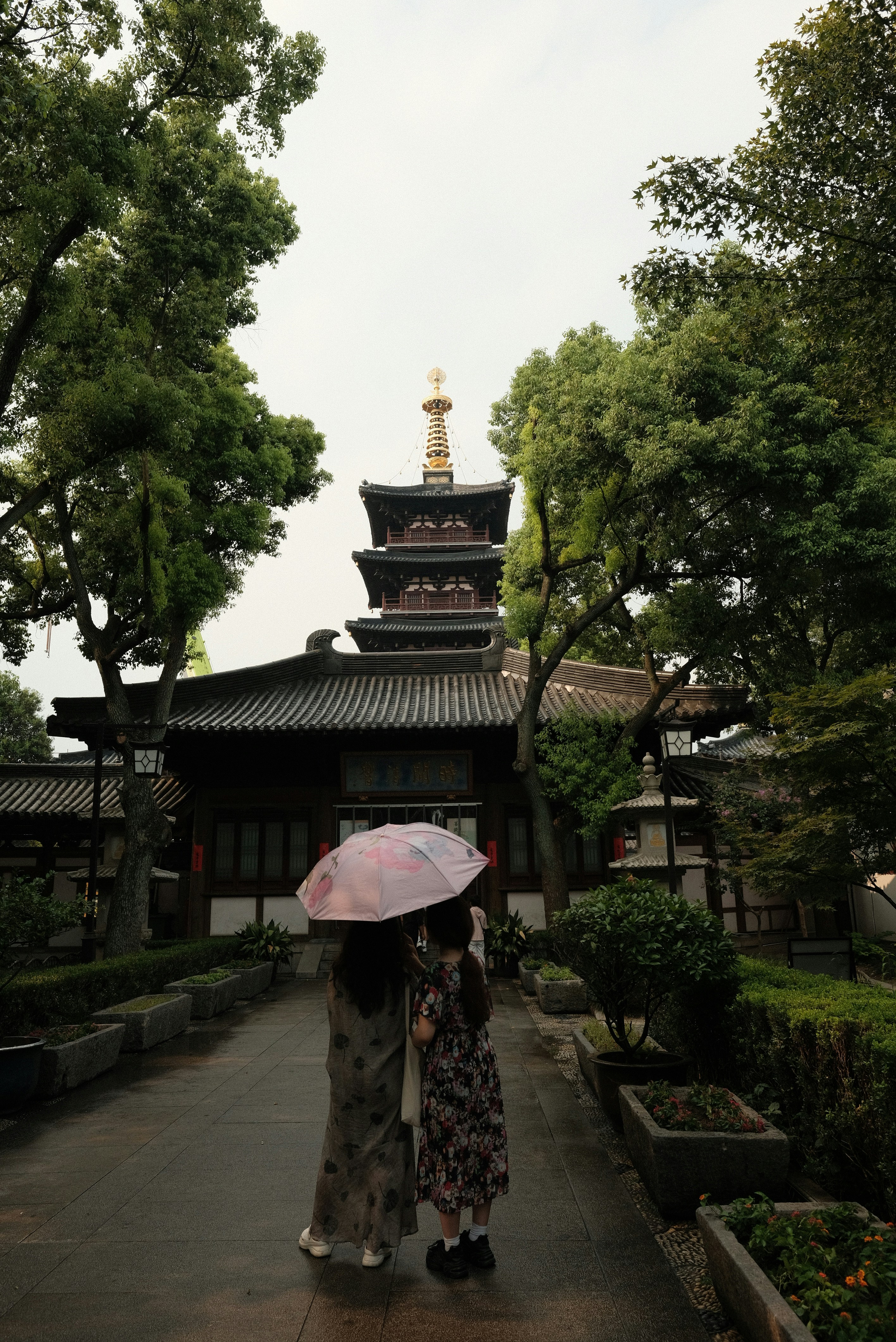Temple Courtyard Duo Under Umbrella