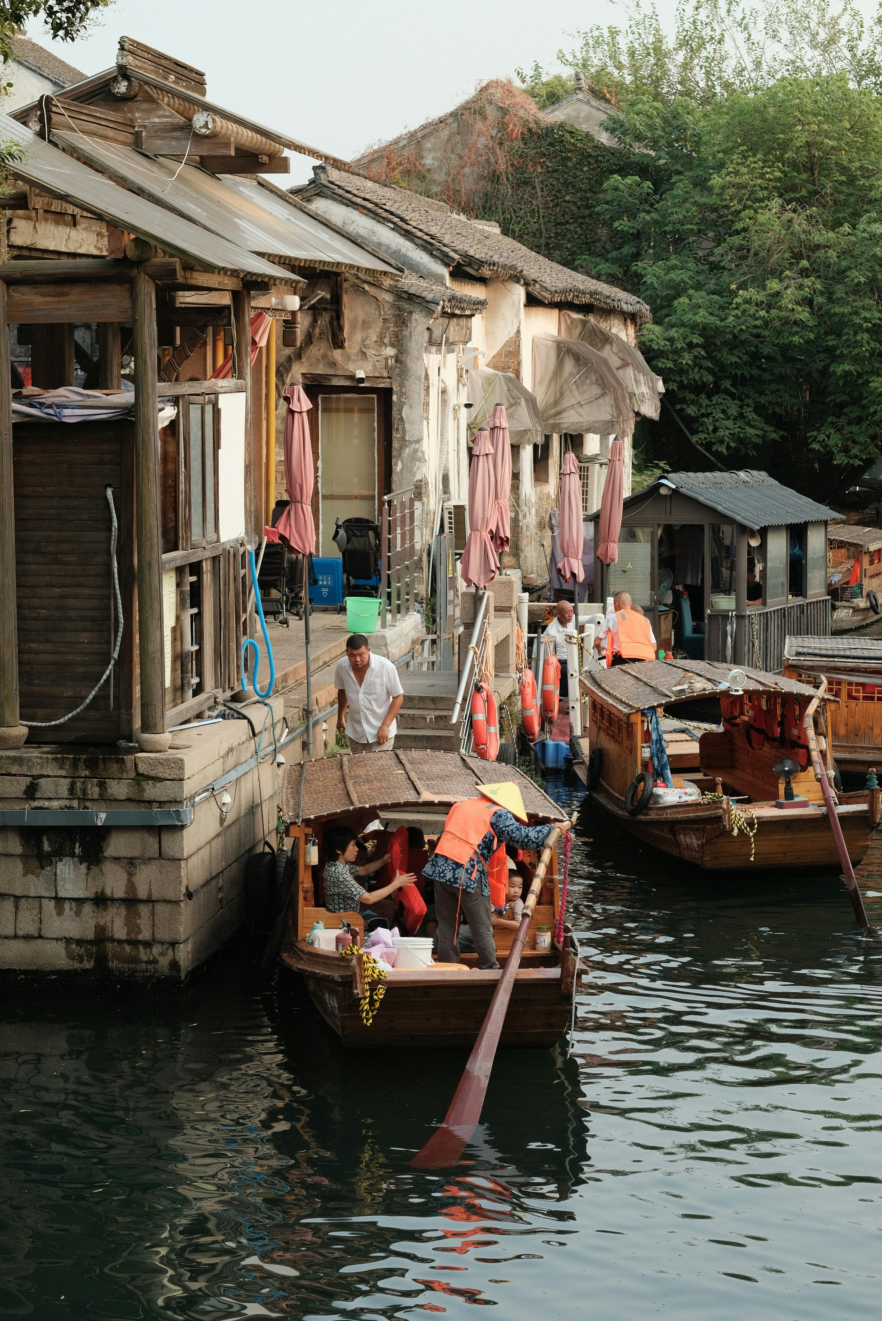 Canalfront Life: Weathered Buildings, Wooden Boats, and Daily Motion