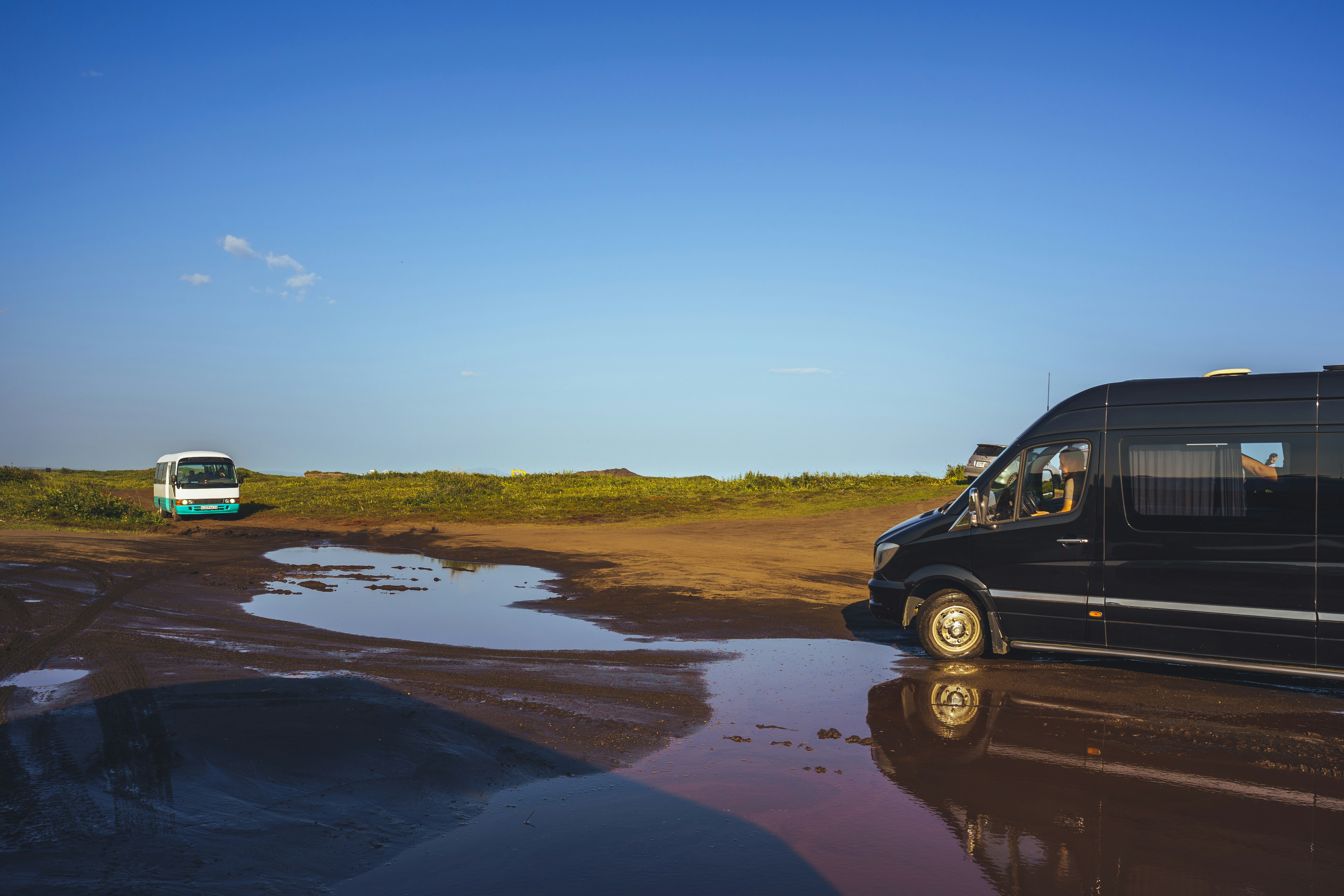 Reflections at the Mudflat Horizon: A Black Van Anchors the Right Field