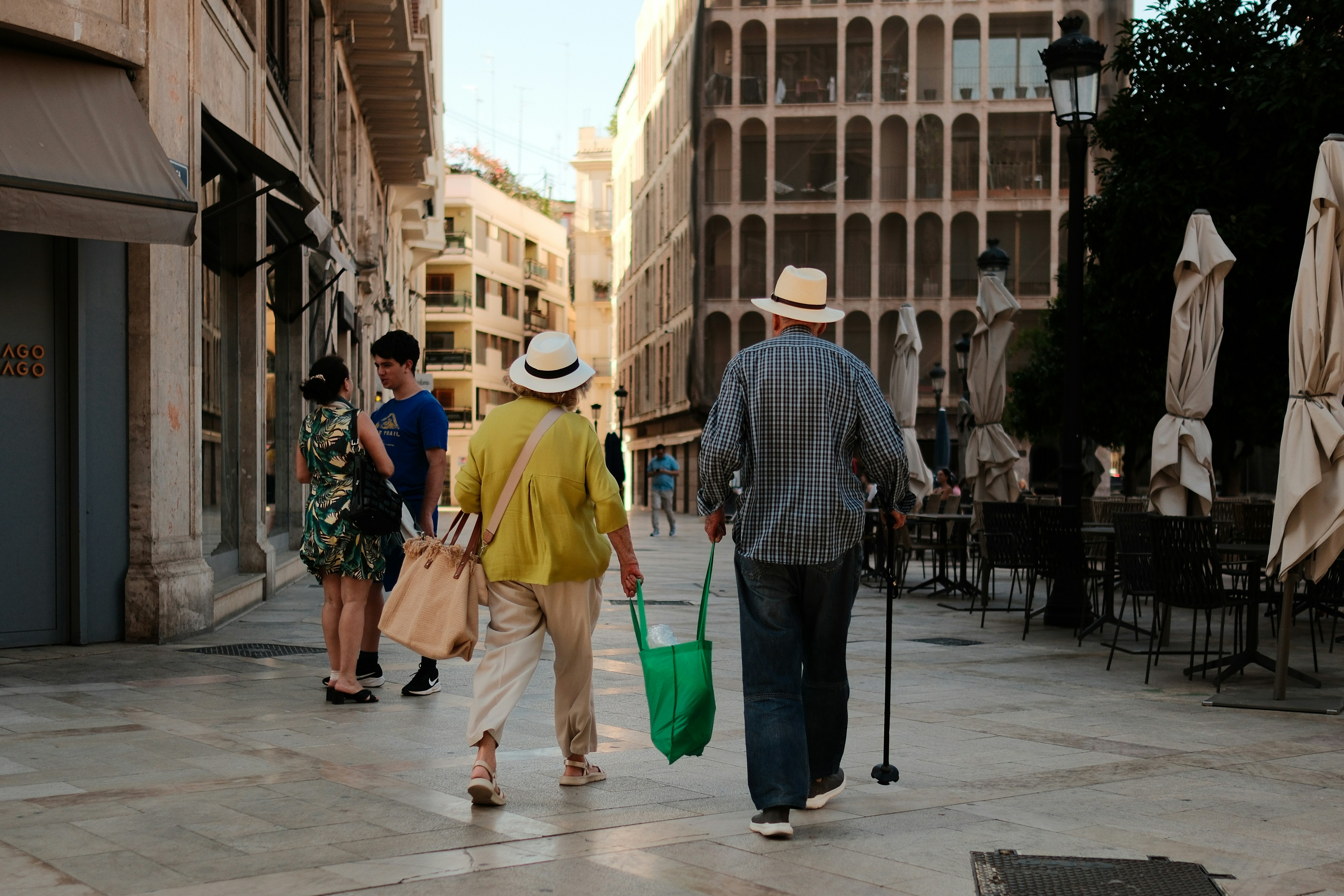 Un grupo de personas caminando por una calle foto – Imagen de ...