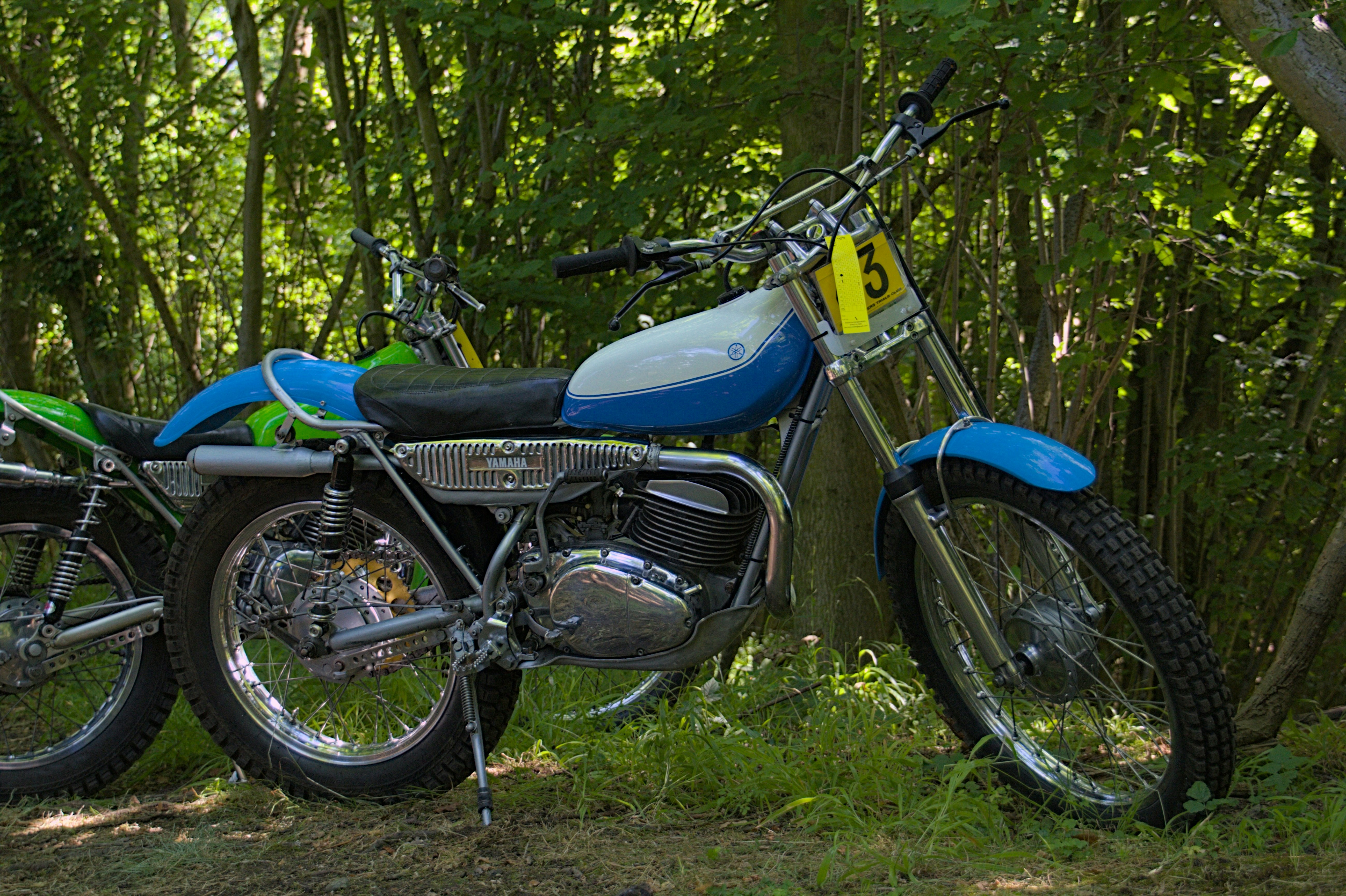 A blue and green motorcycle parked in the woods photo – Free Motorbike ...