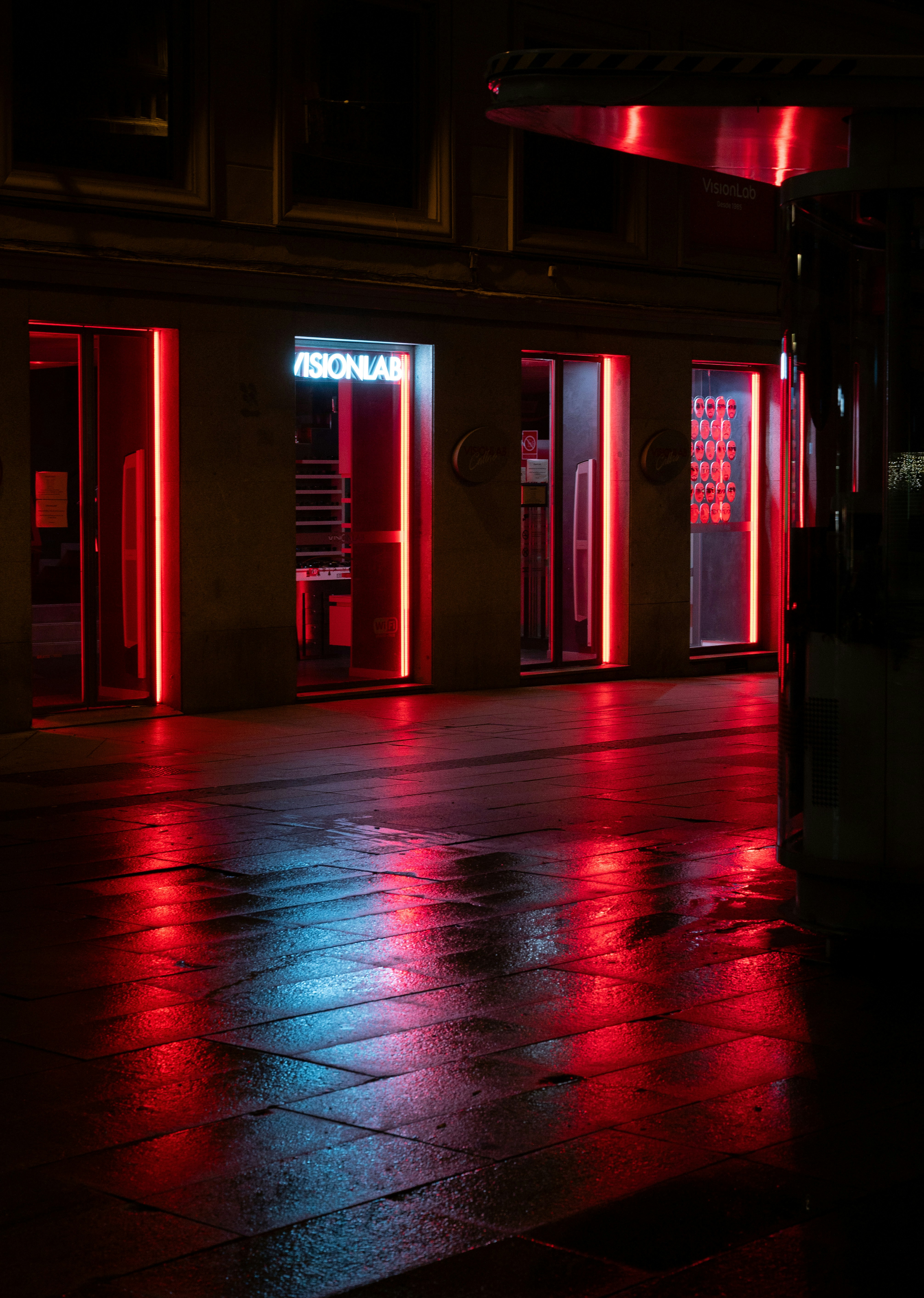 A building with red lights on the side of it photo – Free Madrid Image ...