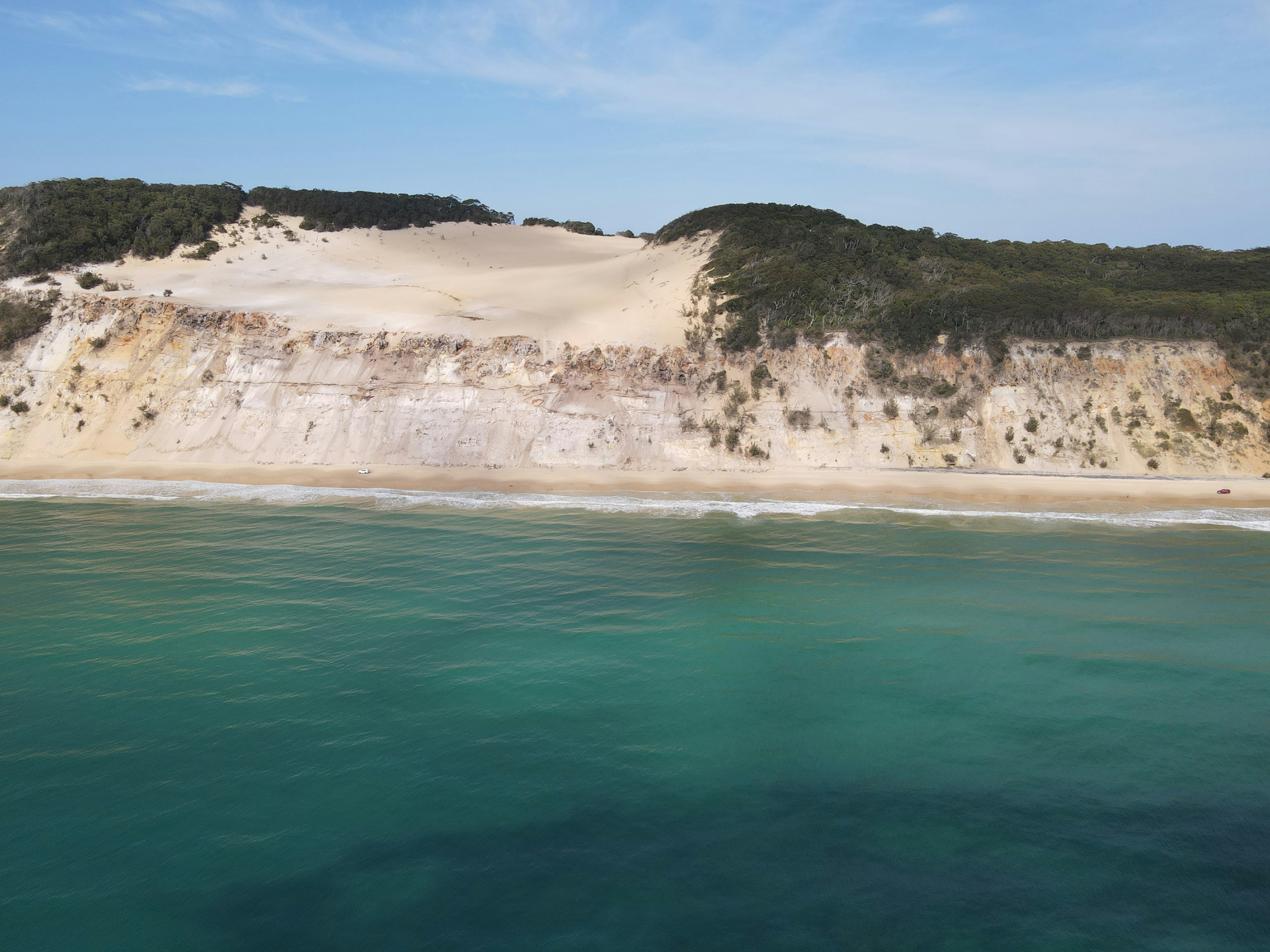 Emerald Coastline from Above: Dunes, White Cliffs, and Turquoise Seas