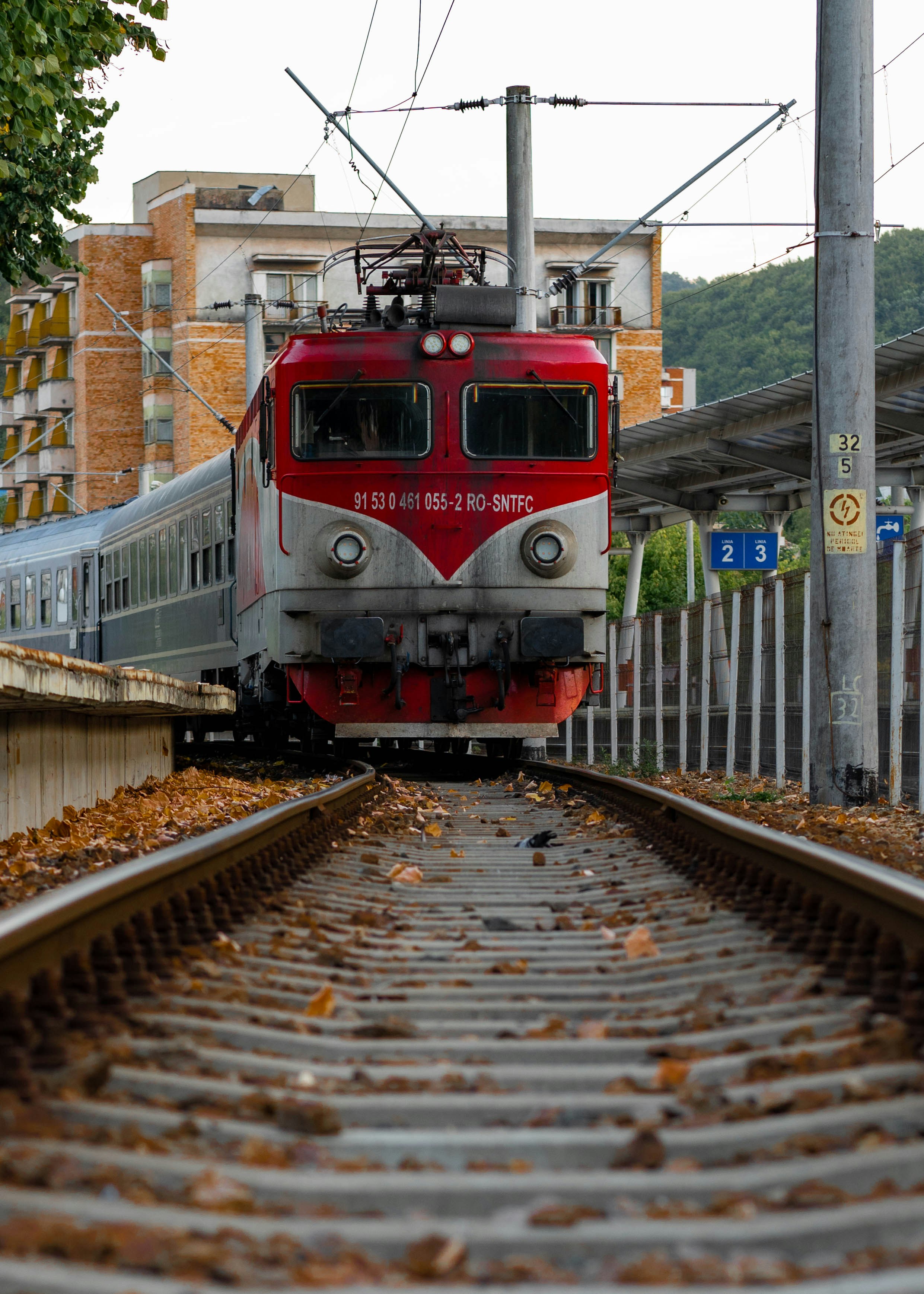 A red and white train traveling down train tracks photo – Free Train ...