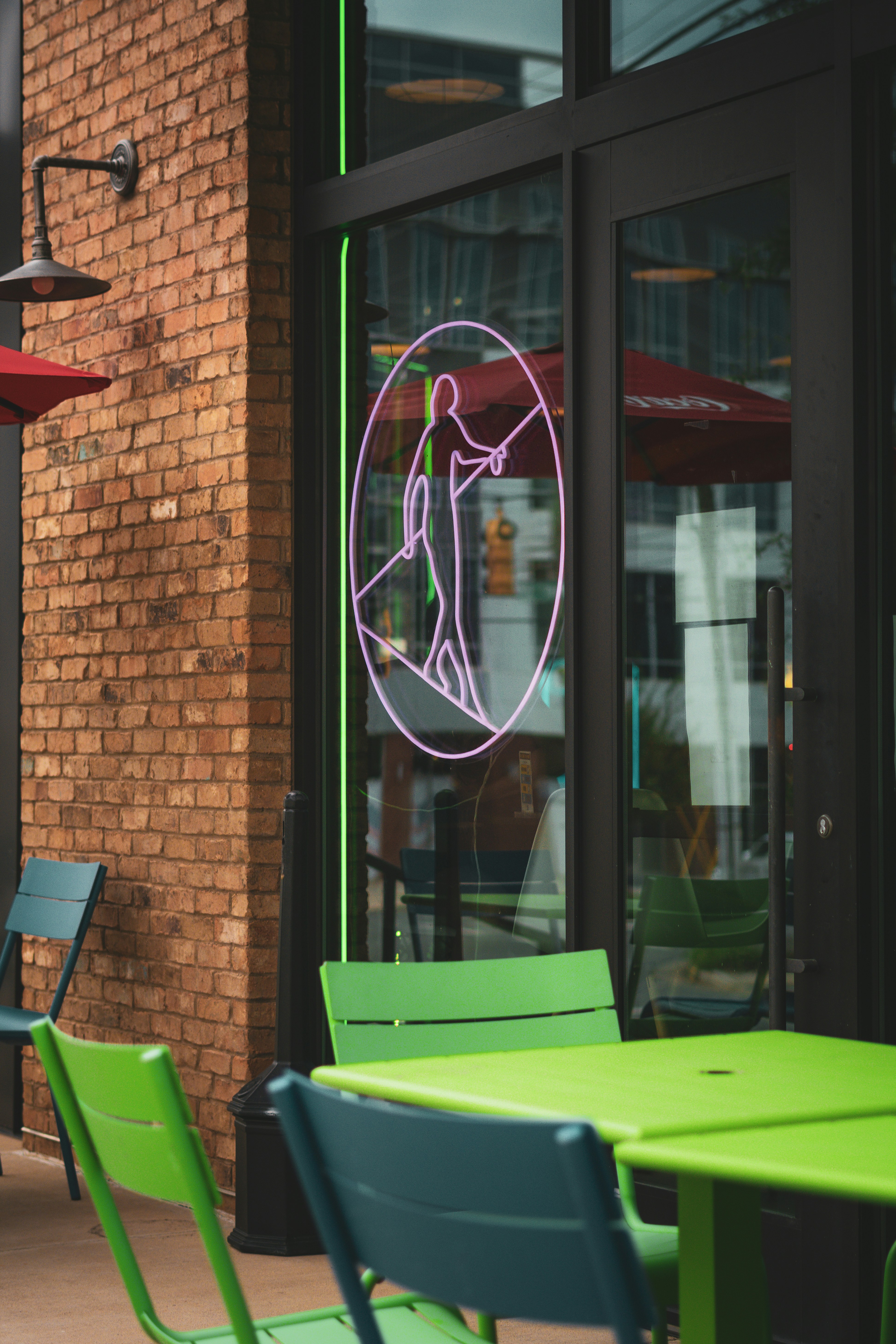 Neon Halo Logo Illuminates a Lime Café Terrace