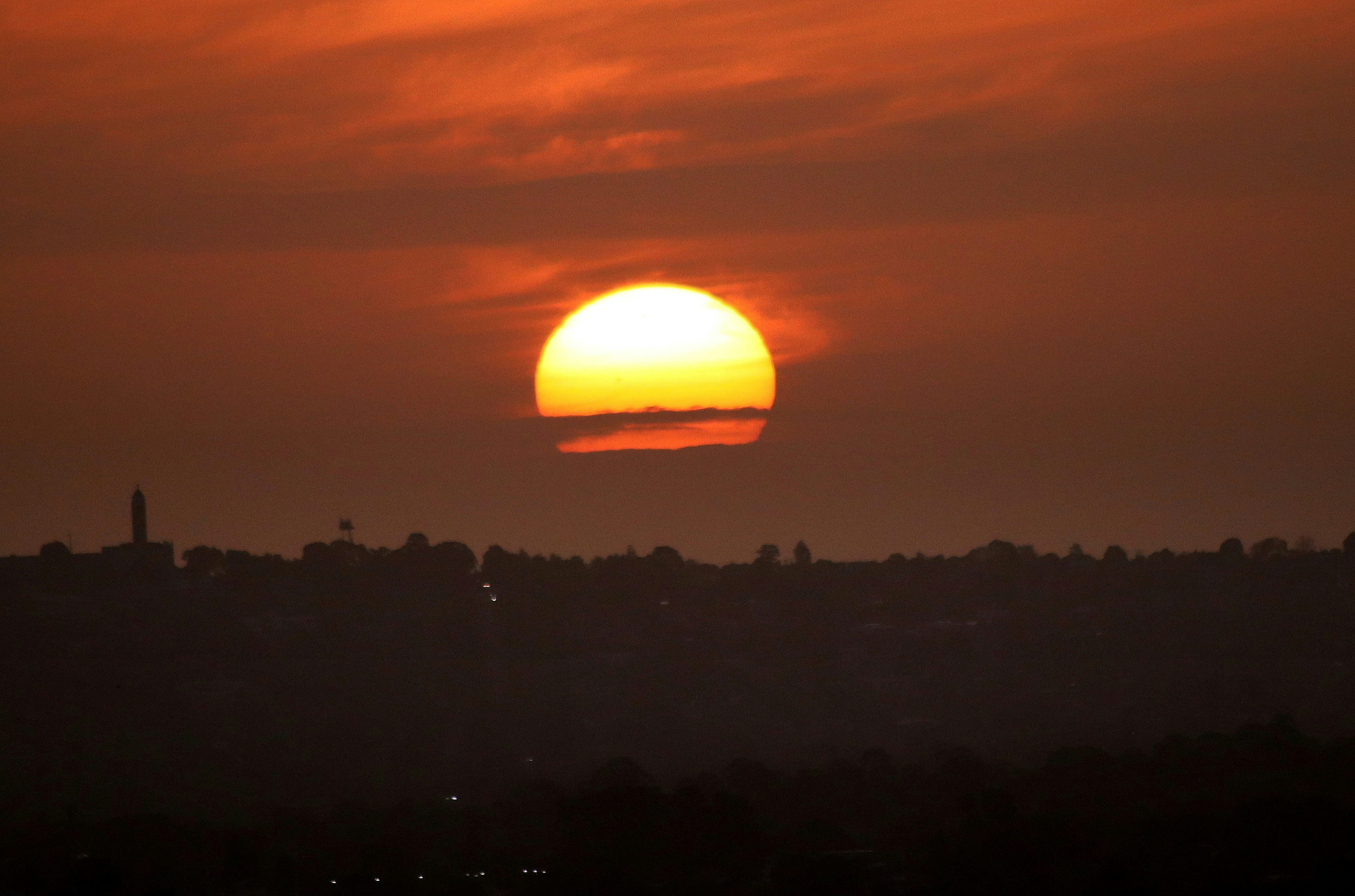 The sun is setting over a city skyline photo – Free Sunset Image on ...