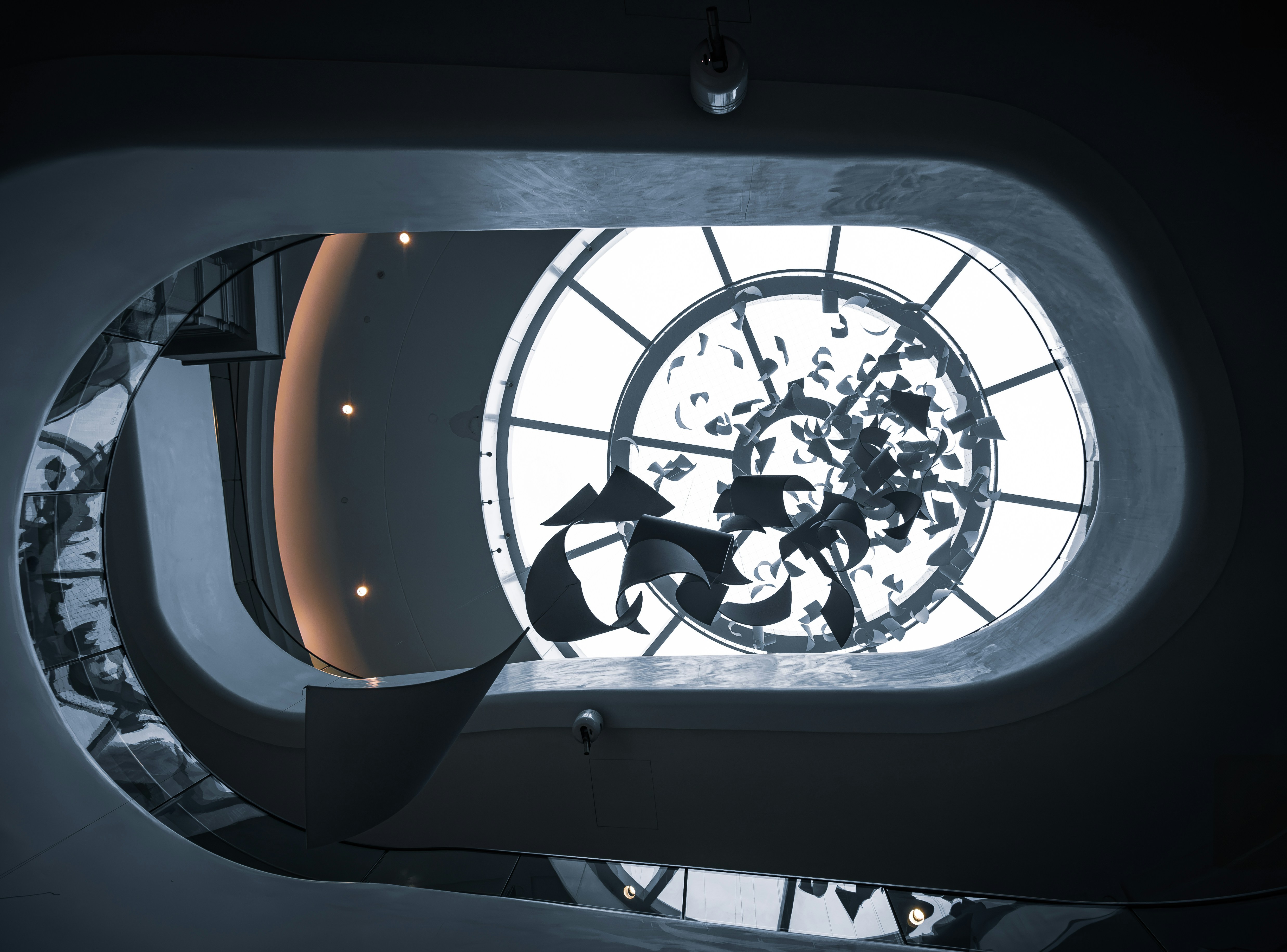 A circular window in a building with a skylight