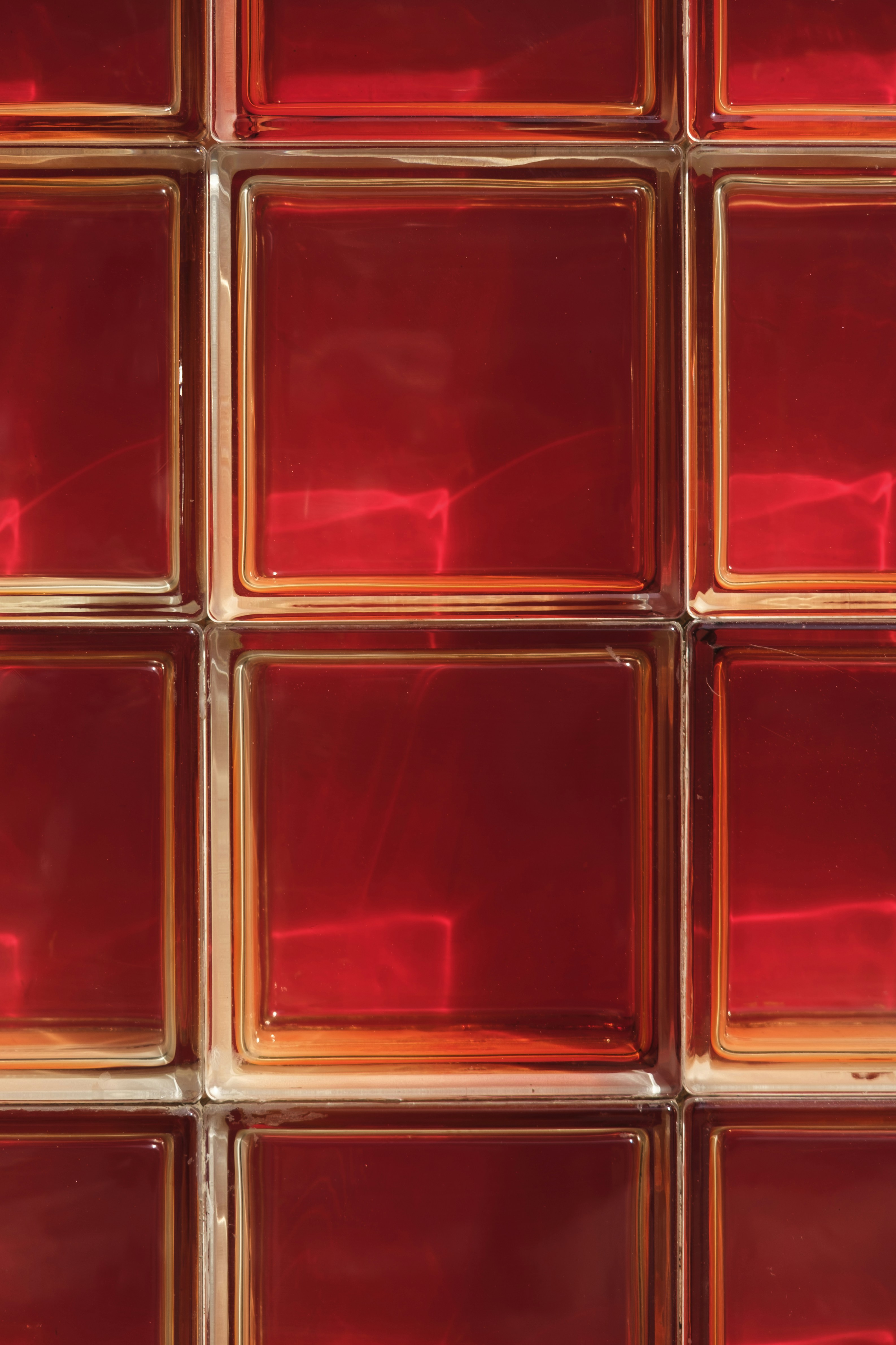 A close up of a red glass block wall photo – Free Red Image on Unsplash