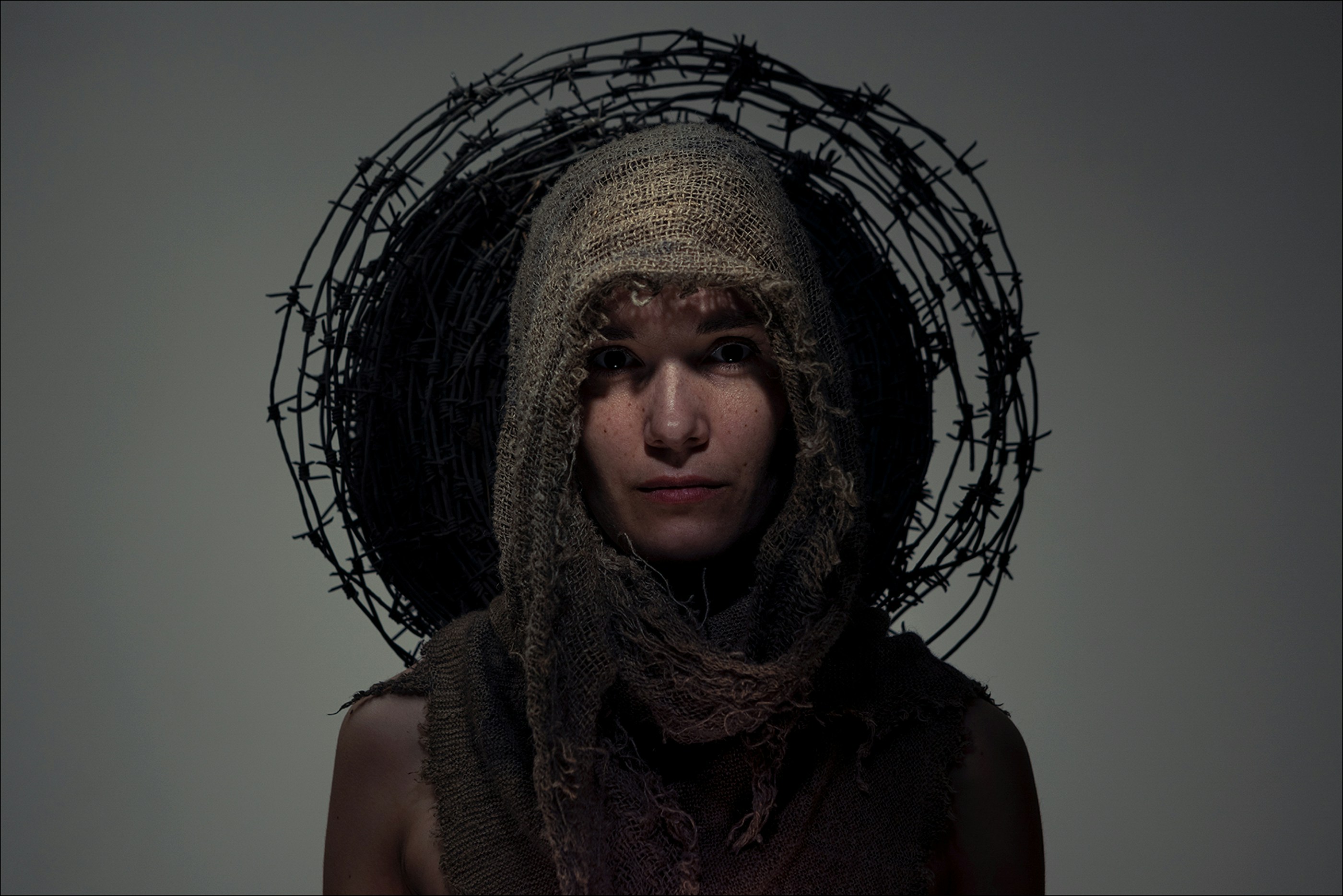 A woman with a hood and barbed wire around her head photo – Free ...