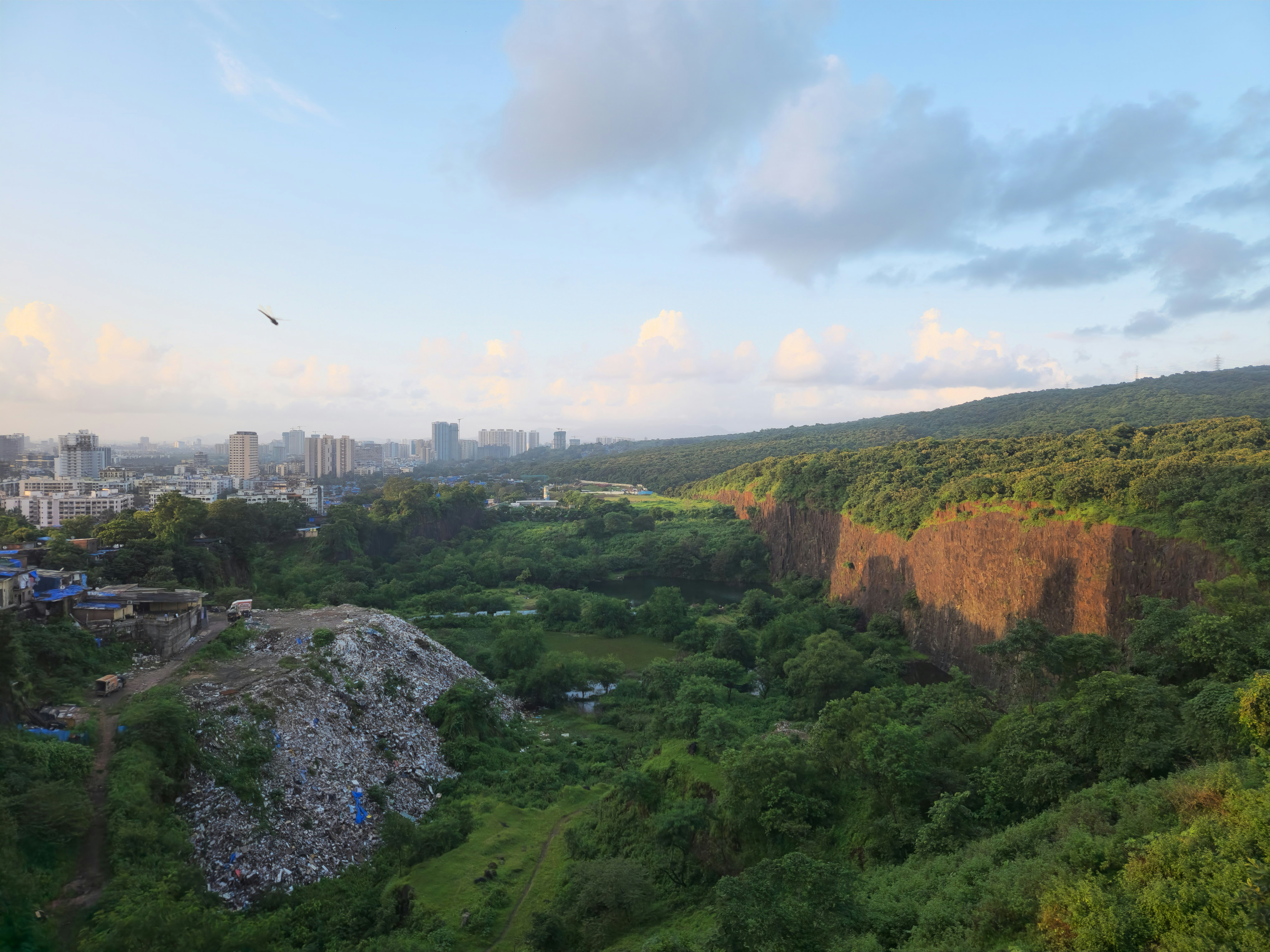 Green valley meets skyline: a cliffside panorama over a thriving city