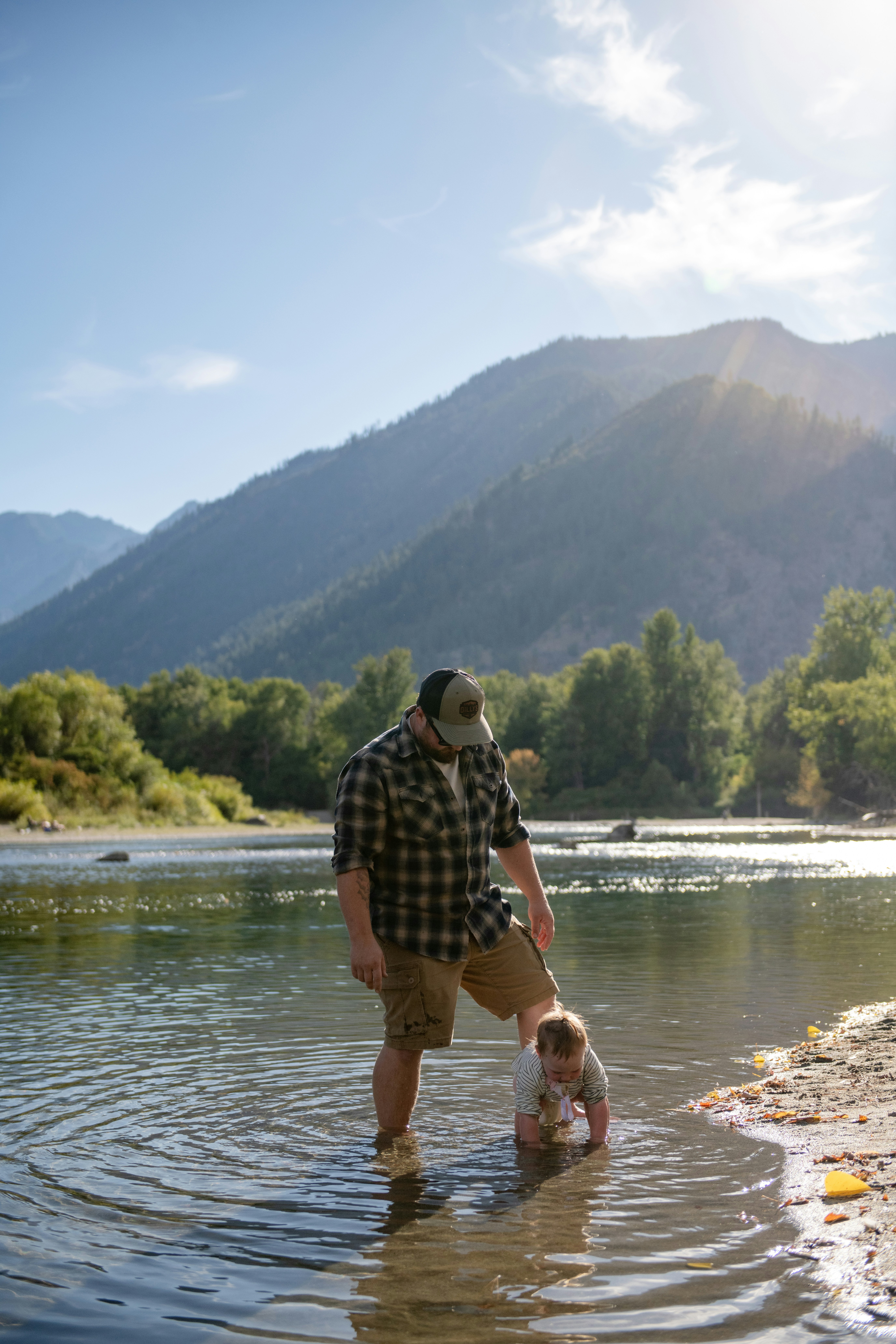 A man standing in a river with a dog photo – Free Sunset Image on Unsplash