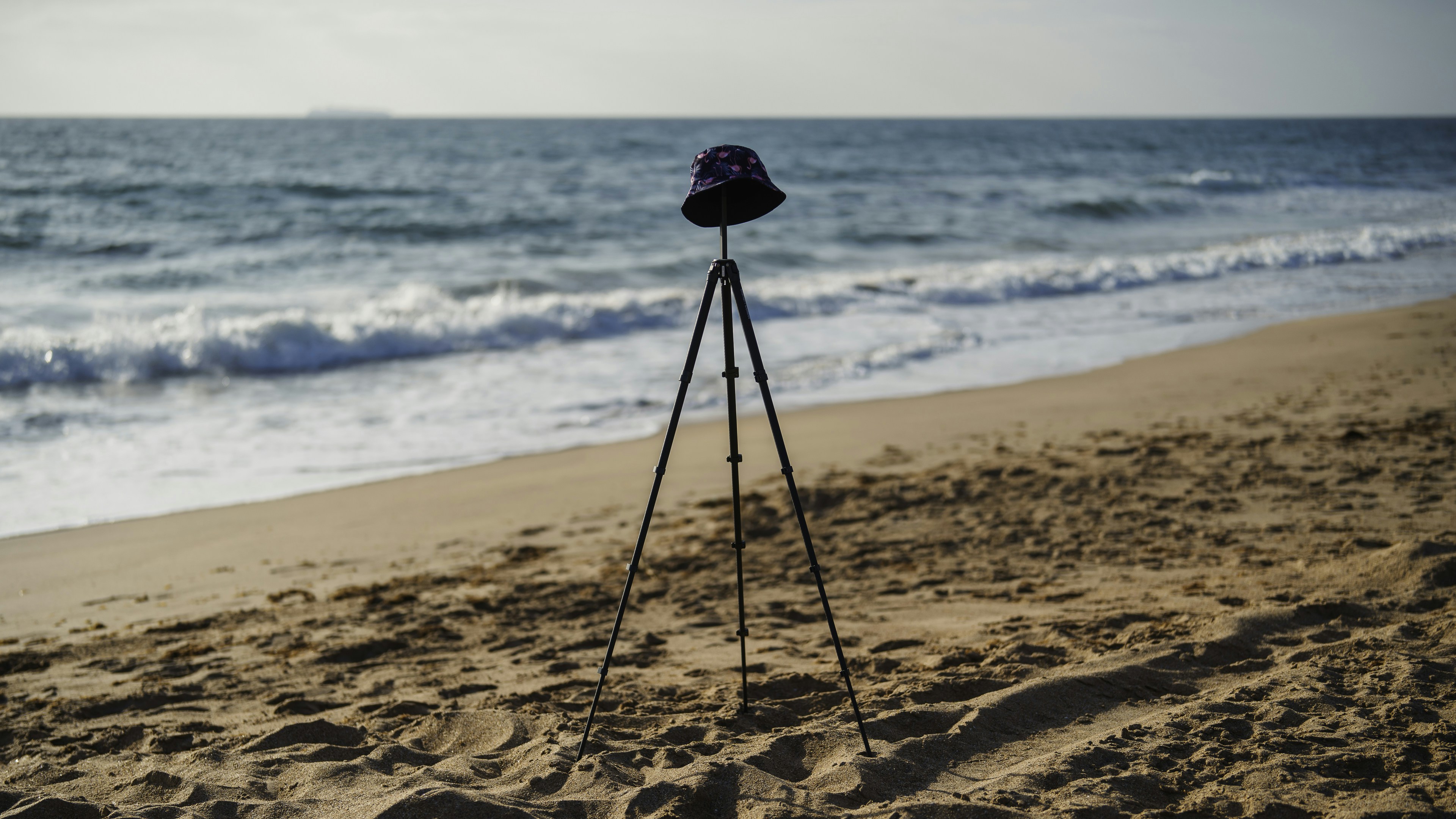 Sentinel on the Shore: A Tripod Standing Against the Sea