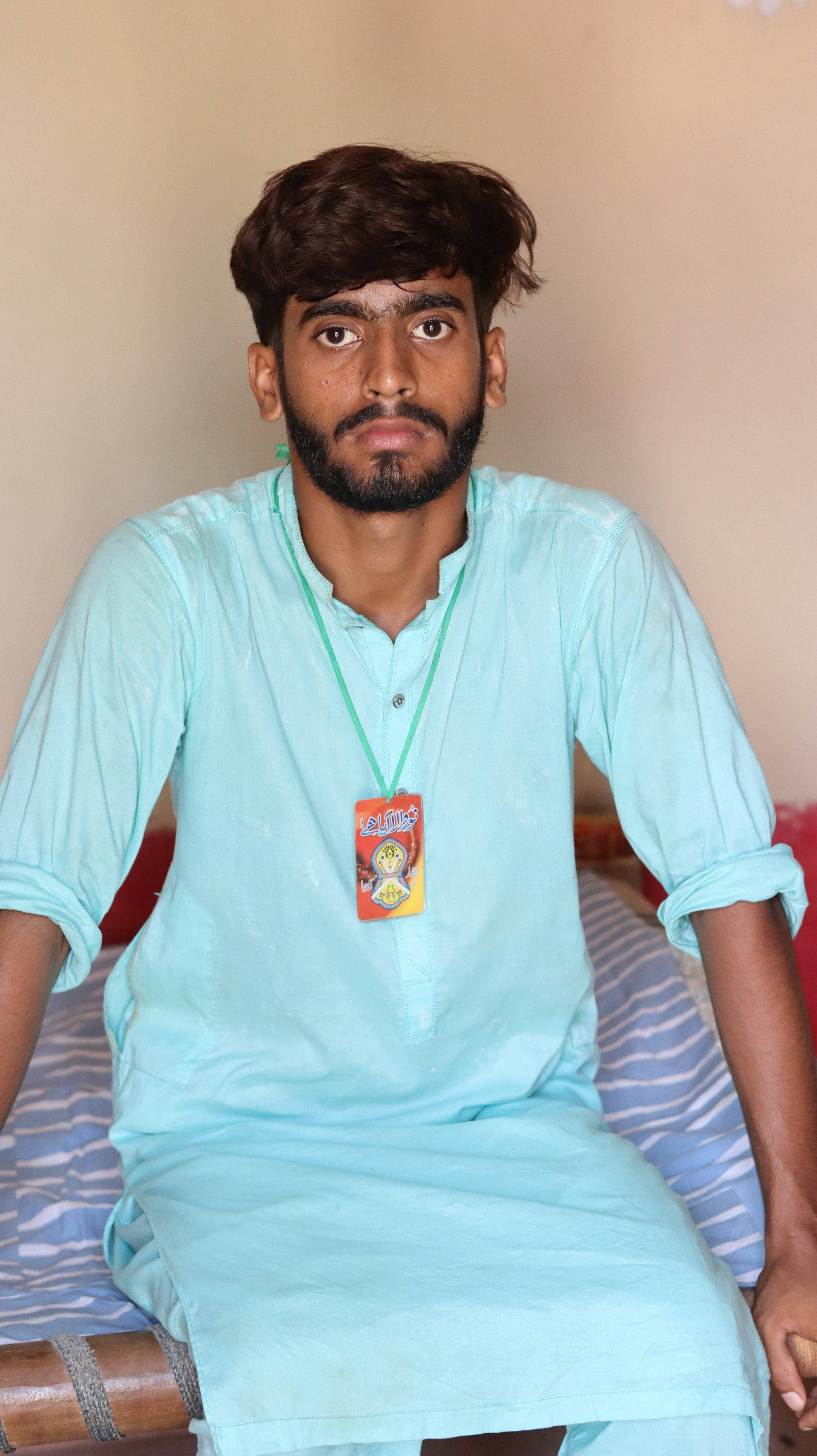 Calm Portrait in Soft Light: A Youthful Gaze in Turquoise Attire
