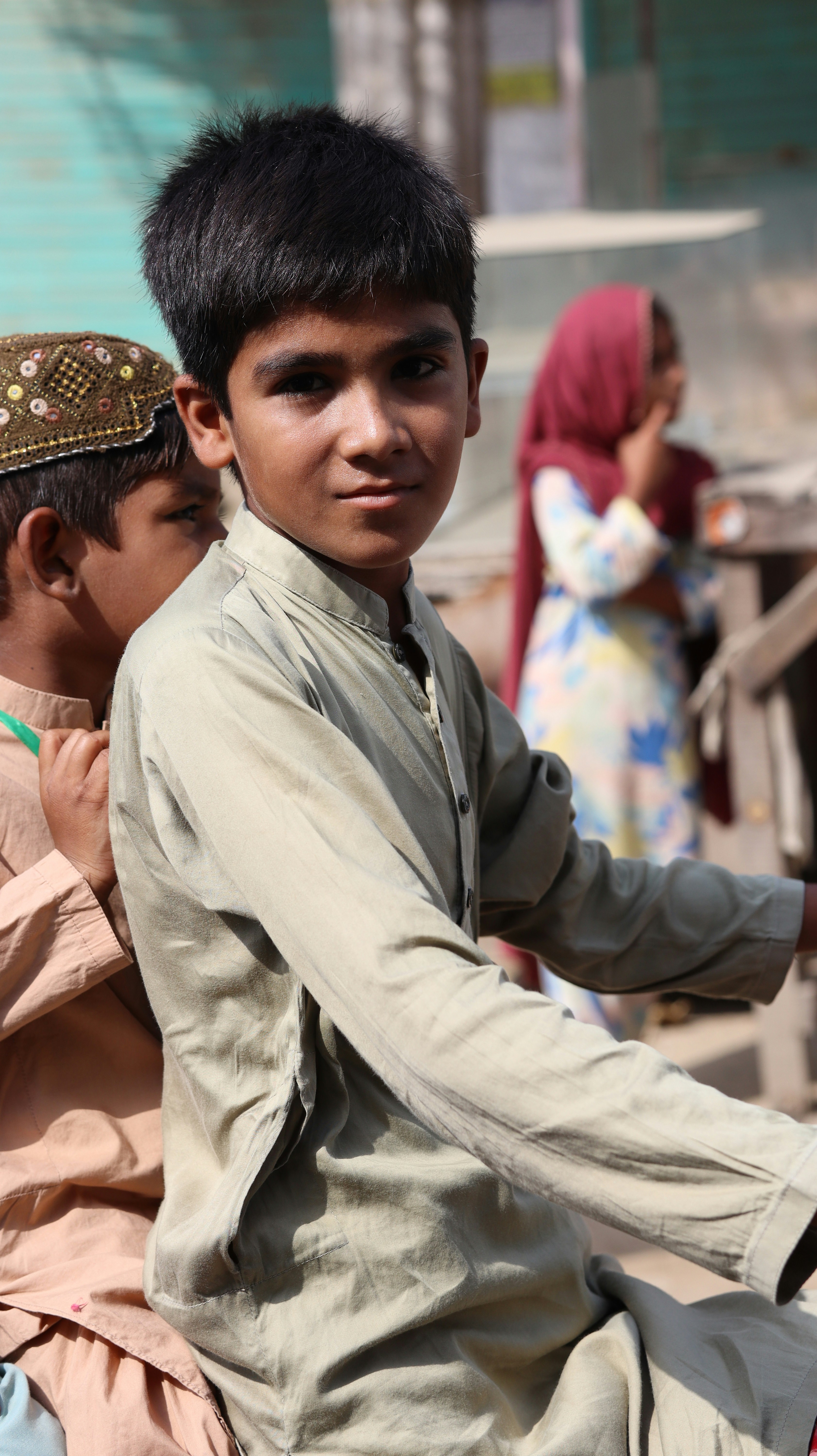 Two young boys are riding a motorcycle together photo – Free Black hair ...