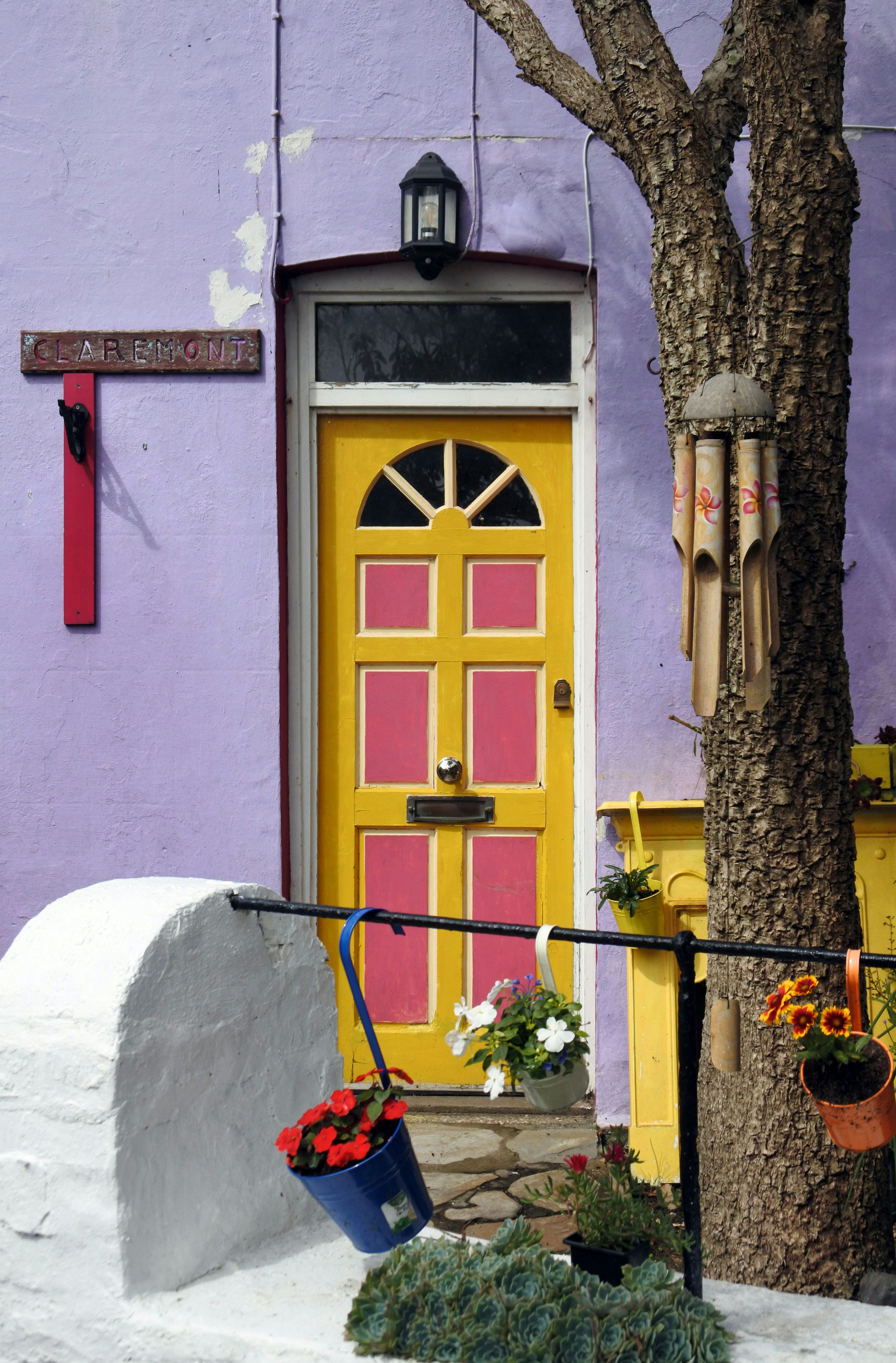 Color-block Portal: A Yellow Door with Pink Panels Set in Lavender Walls
