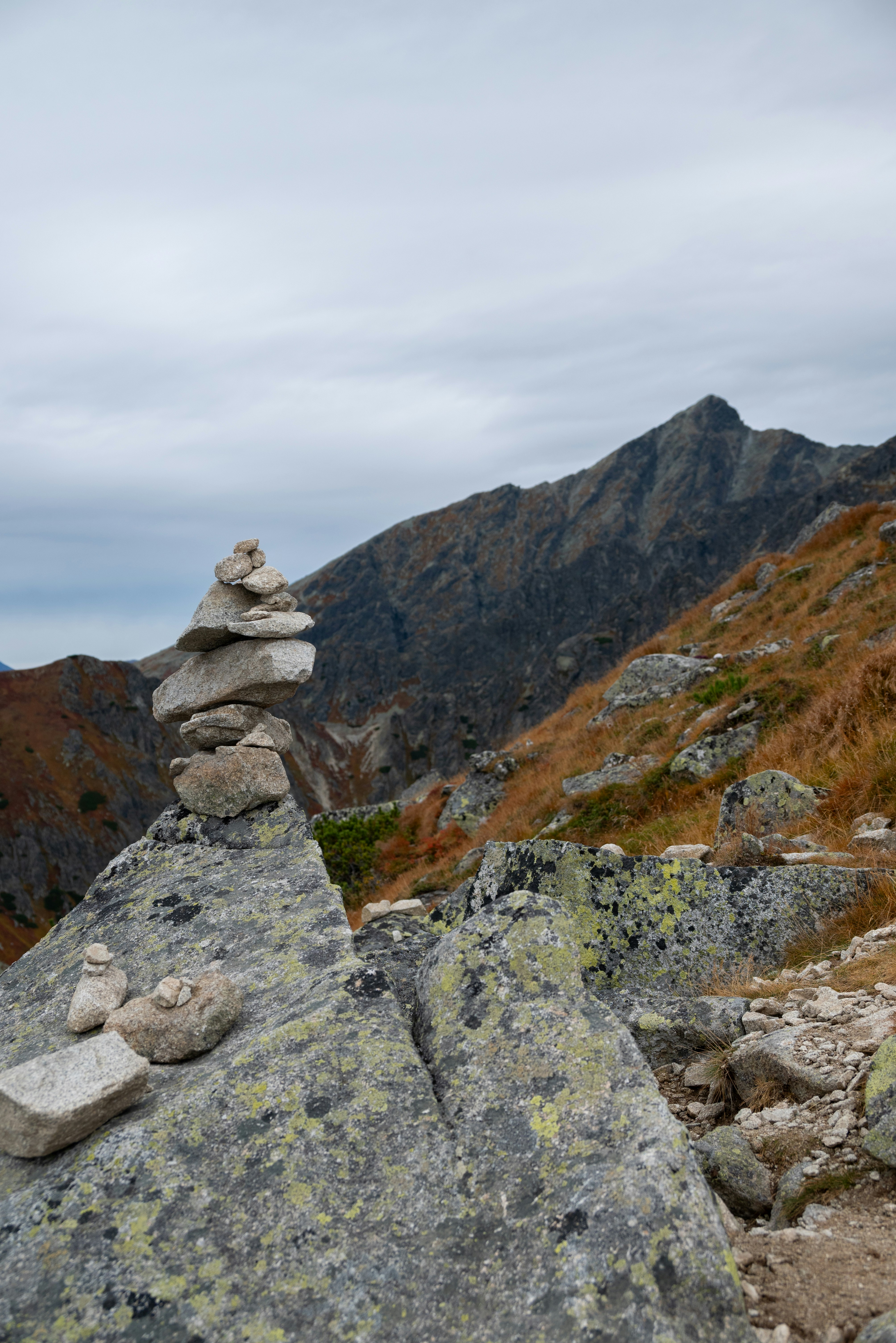 Cairn at the Edge: A Stone Stack on a Wind-Swept Alpine Ridge