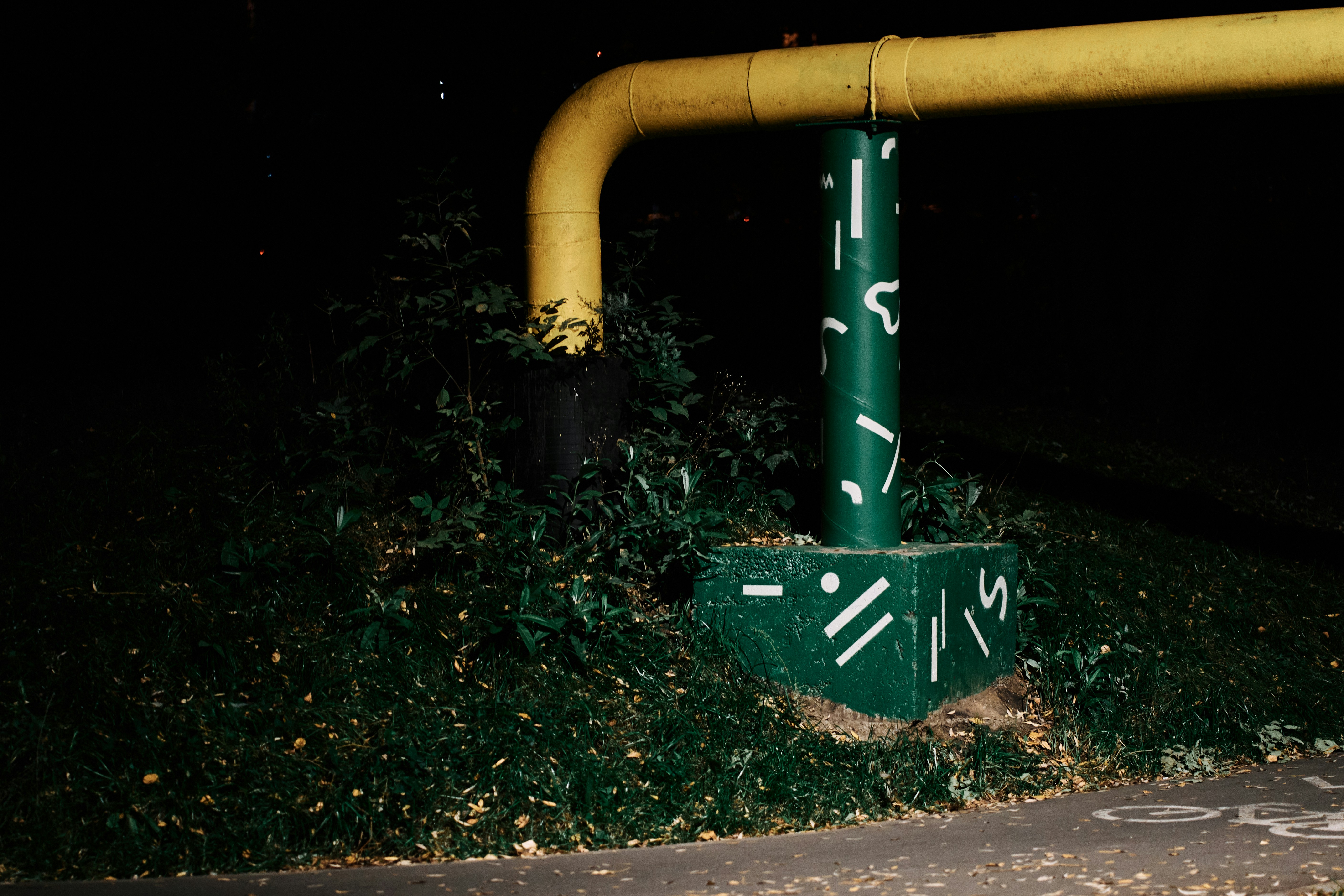 A green street sign sitting on the side of a road