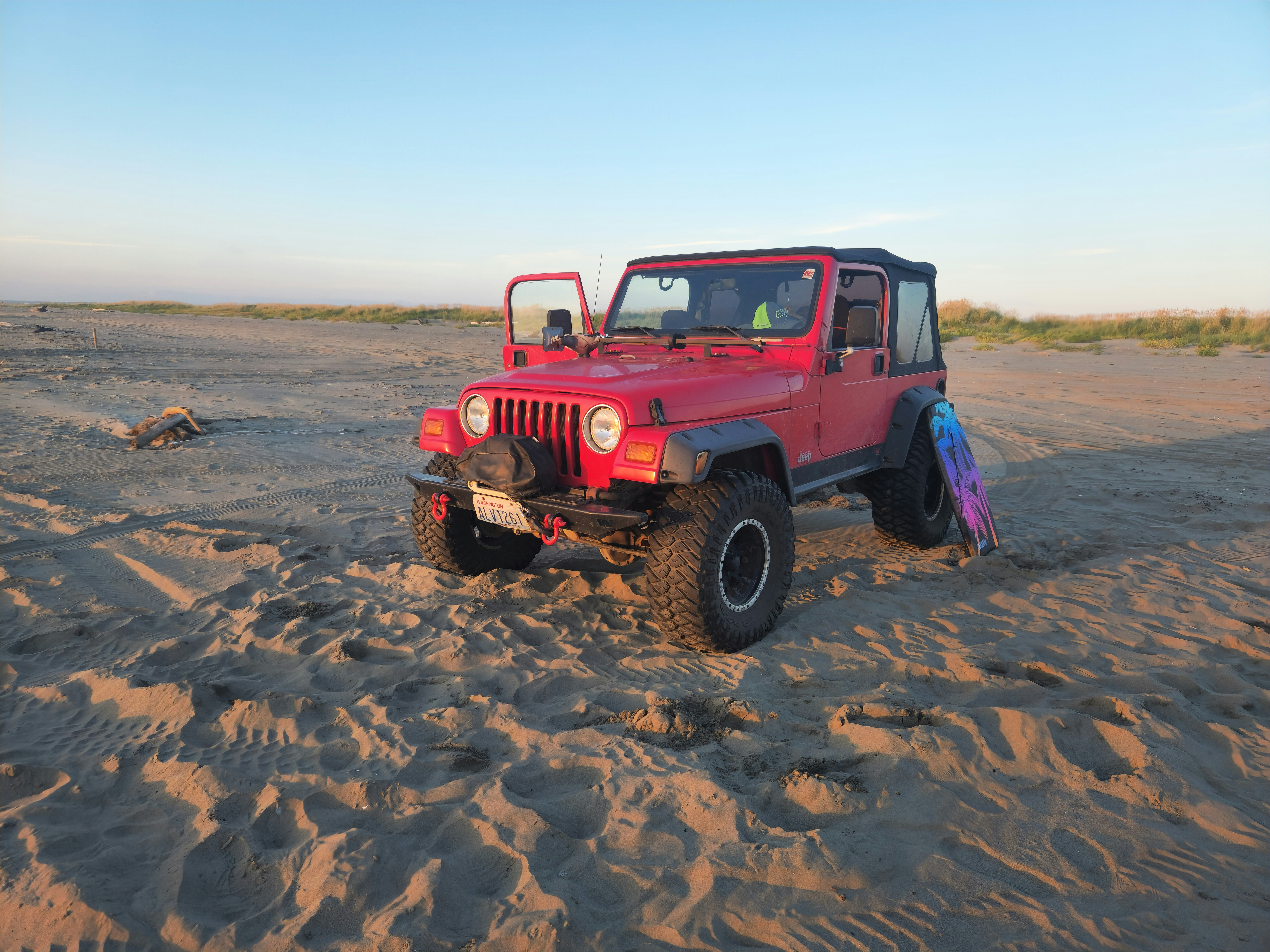 A red jeep parked on top of a sandy beach photo – Free Ocean shores ...