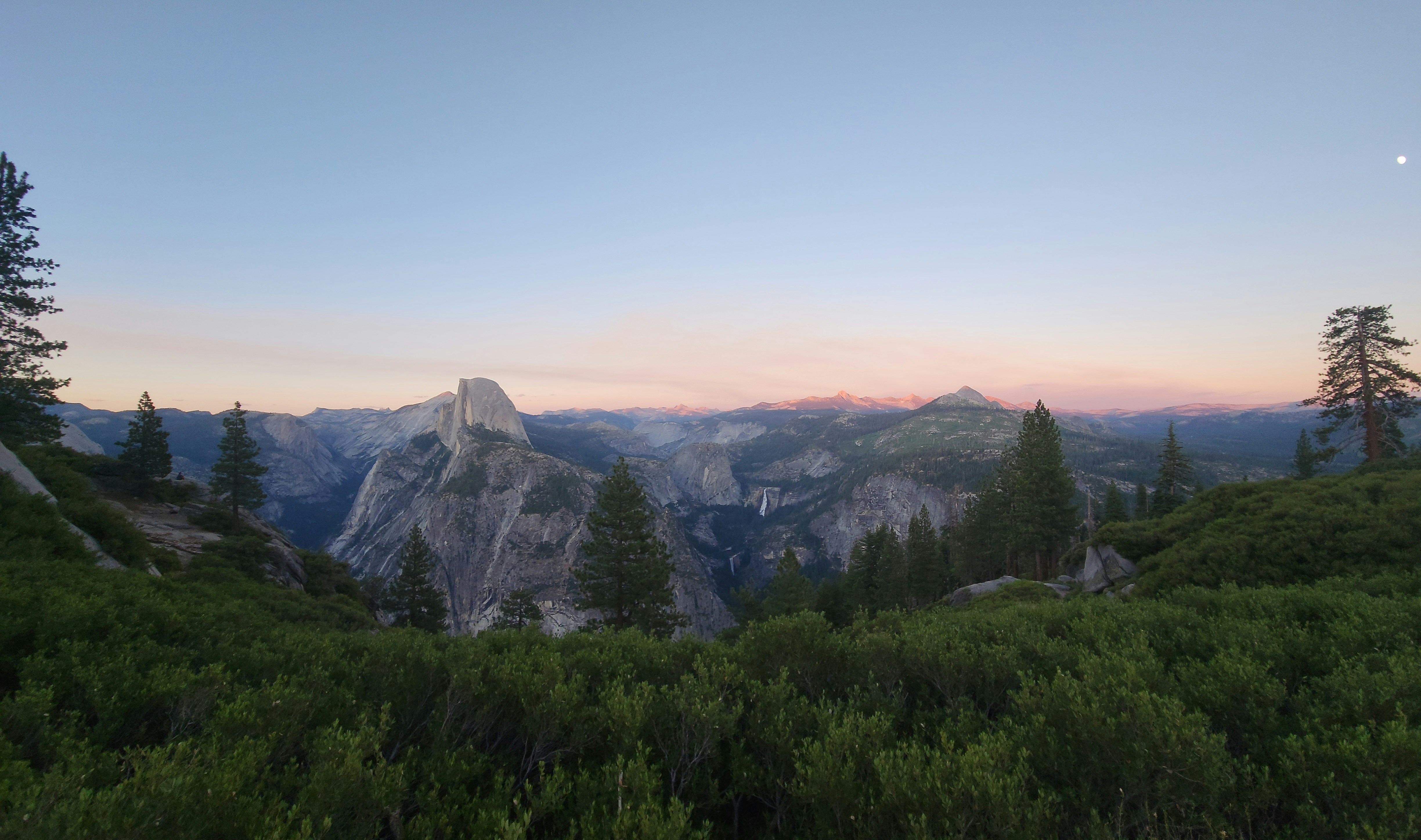 Alpenglow Along a Granite Skyline: Pines Framing a Half Dome-like Summit at Dawn