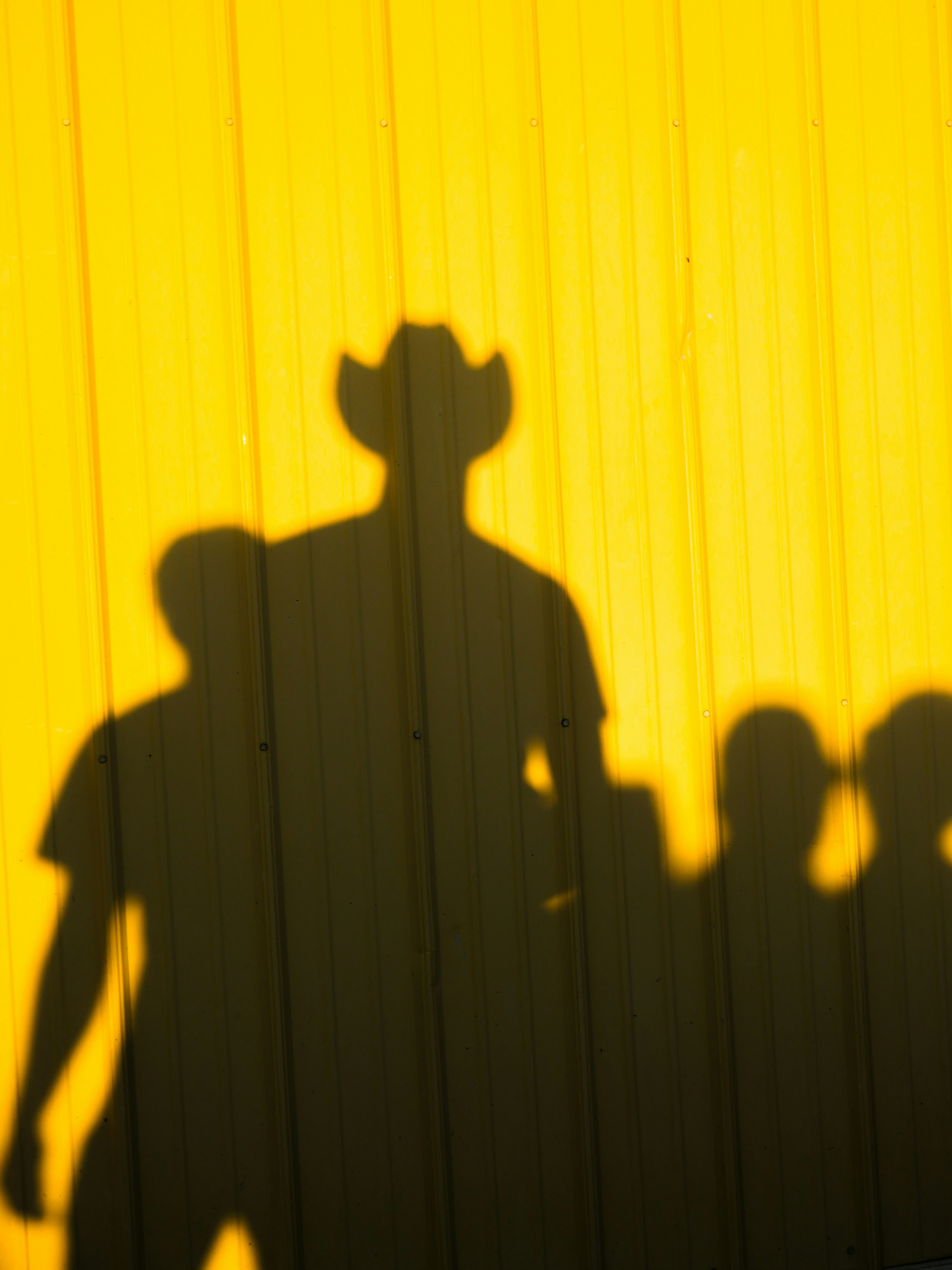 A shadow of a cowboy on a yellow wall photo – Free Experimental Image ...