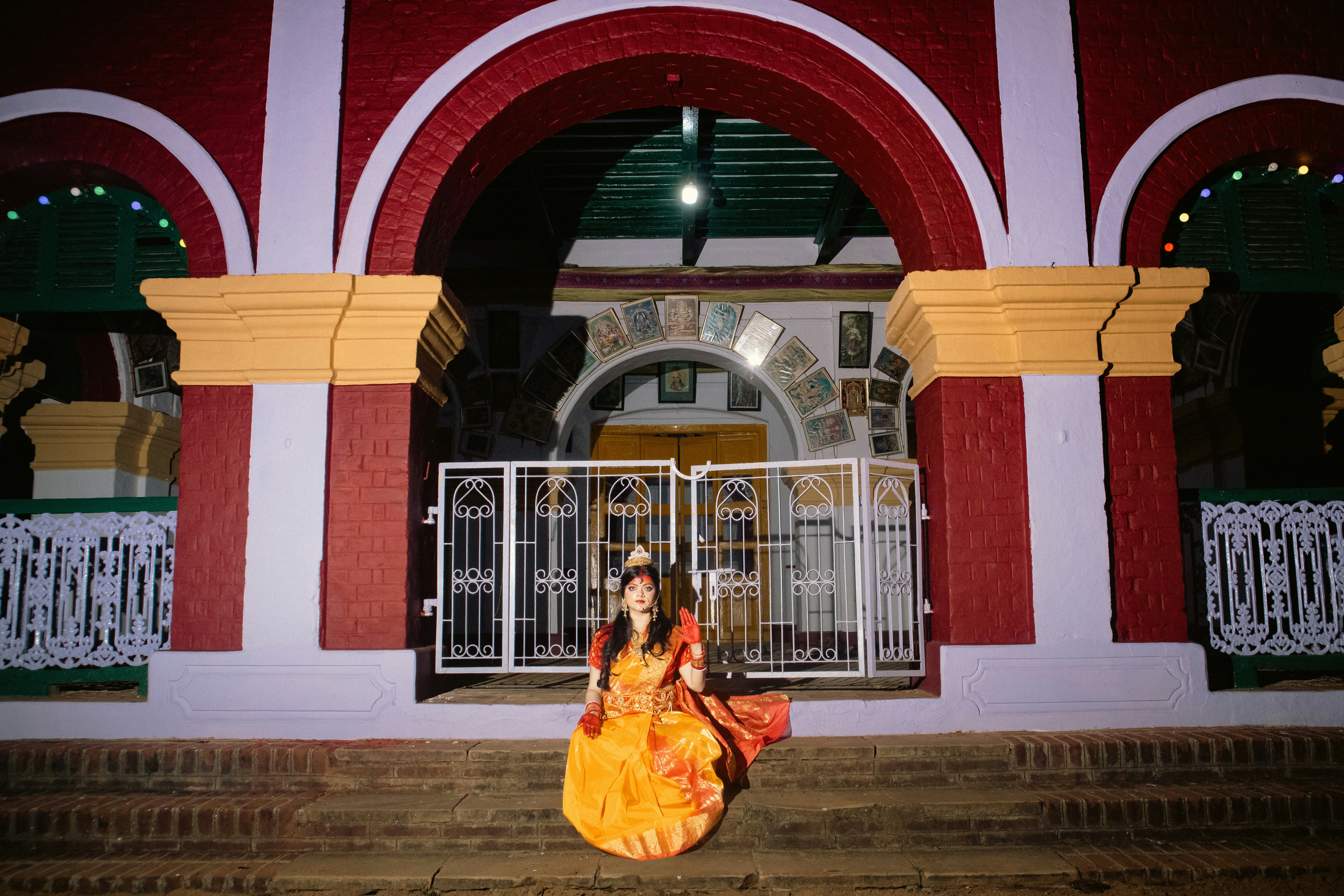 Orange Silk Under Colorful Archways: a quiet moment on sunlit steps
