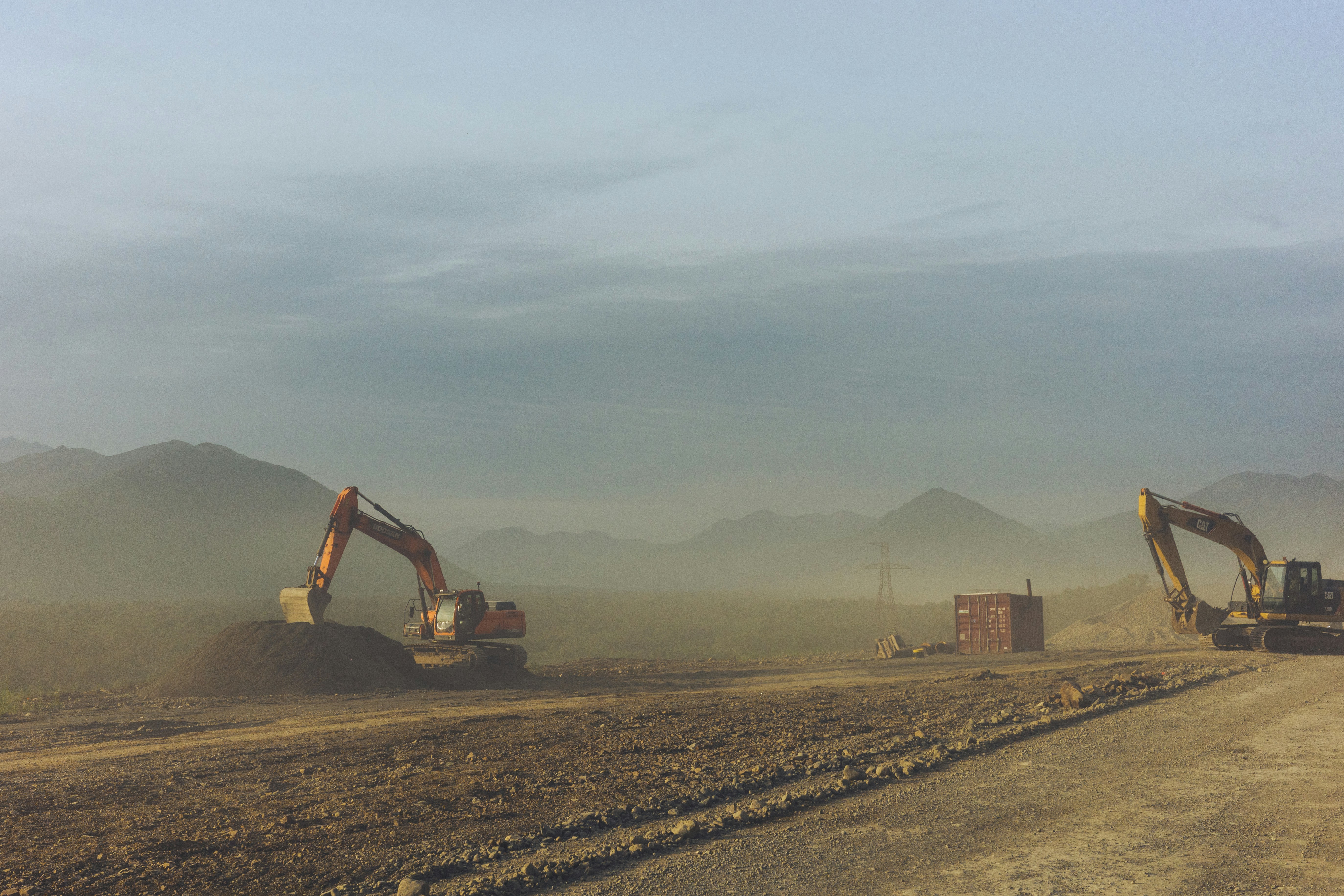 Dawn in the Dust: Two Excavators Carving Silence at a Quarry