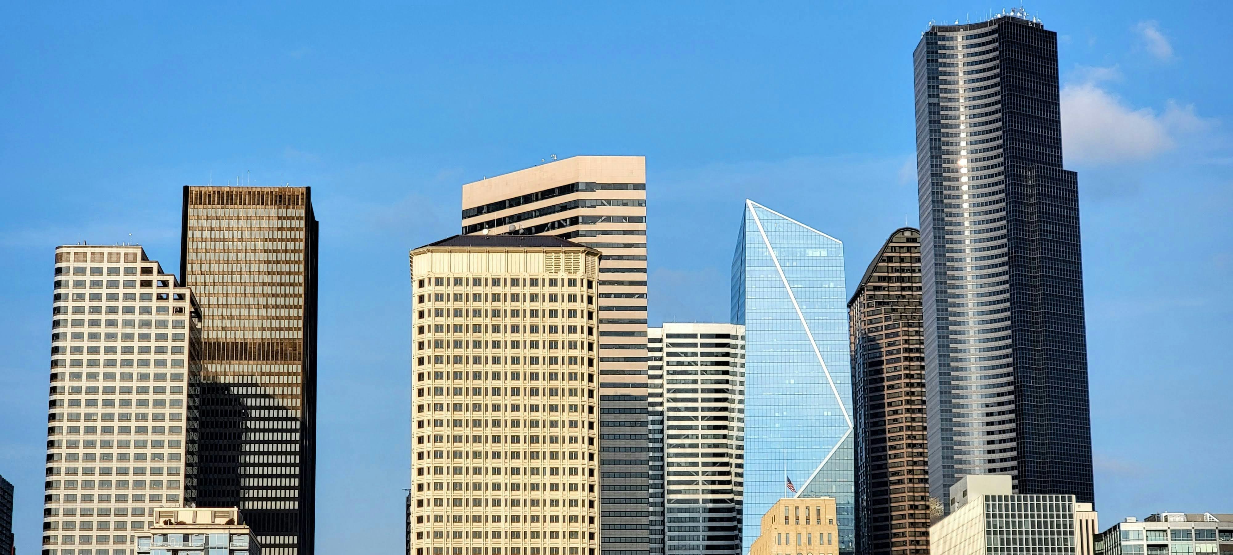 A group of tall buildings sitting next to each other photo – Free ...