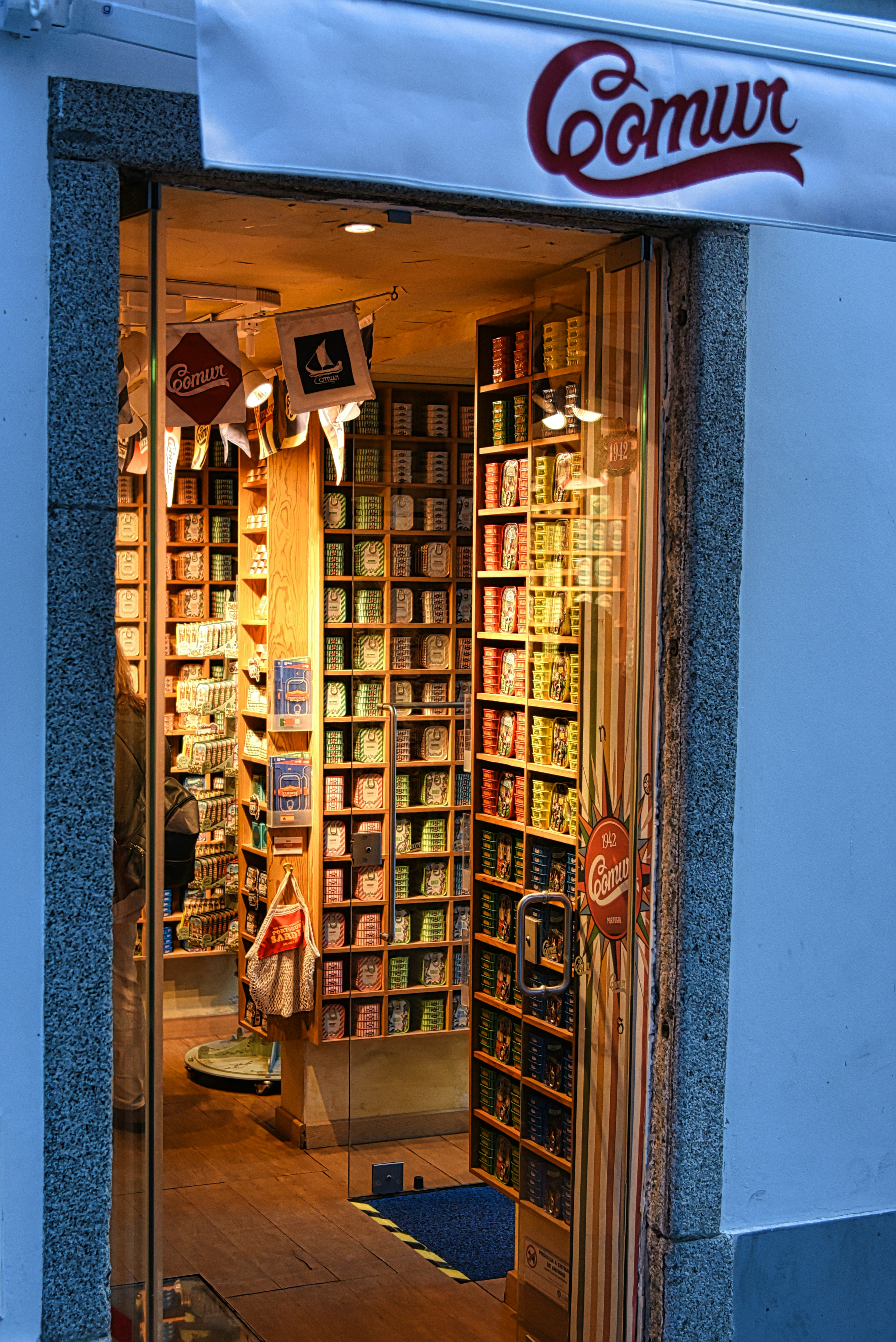 Narrow Candyfront: Warm Light Unfolds a Wall of Colorful Confections