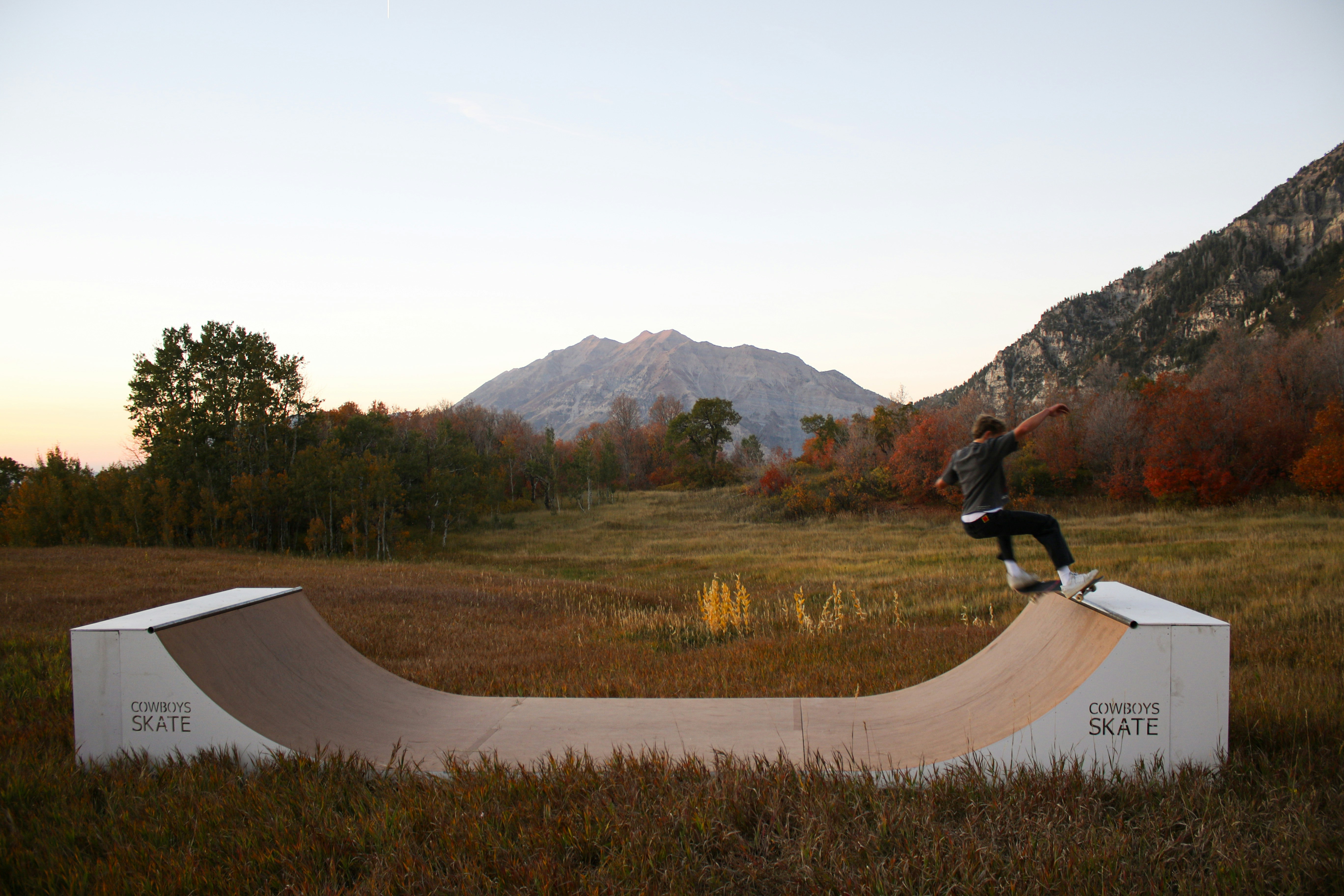 Skater Jumps the Dawn-Soft Arc in Open Field