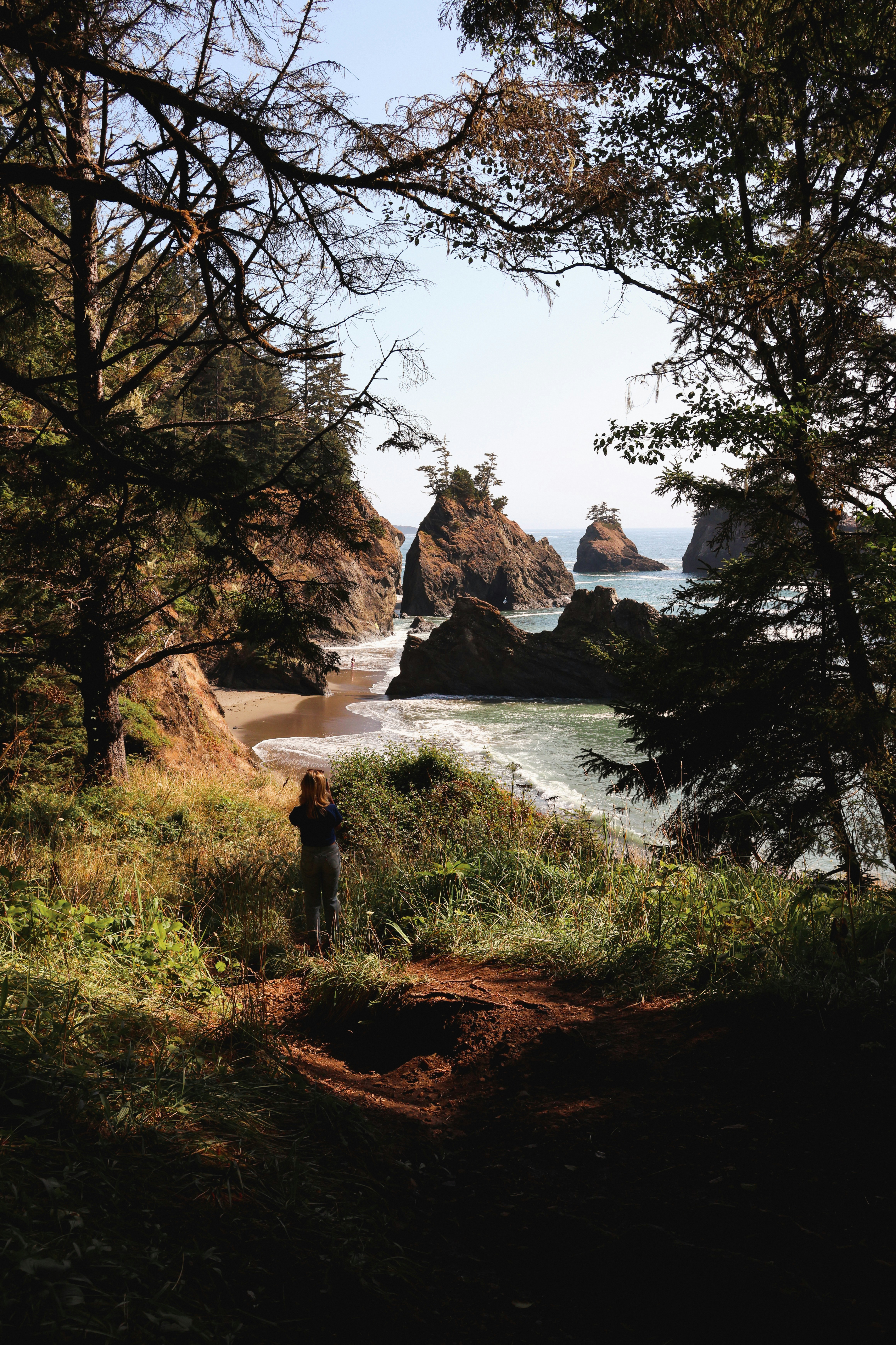 Cliffside Vista: A Lone Figure Amid Ocean Rock Formations