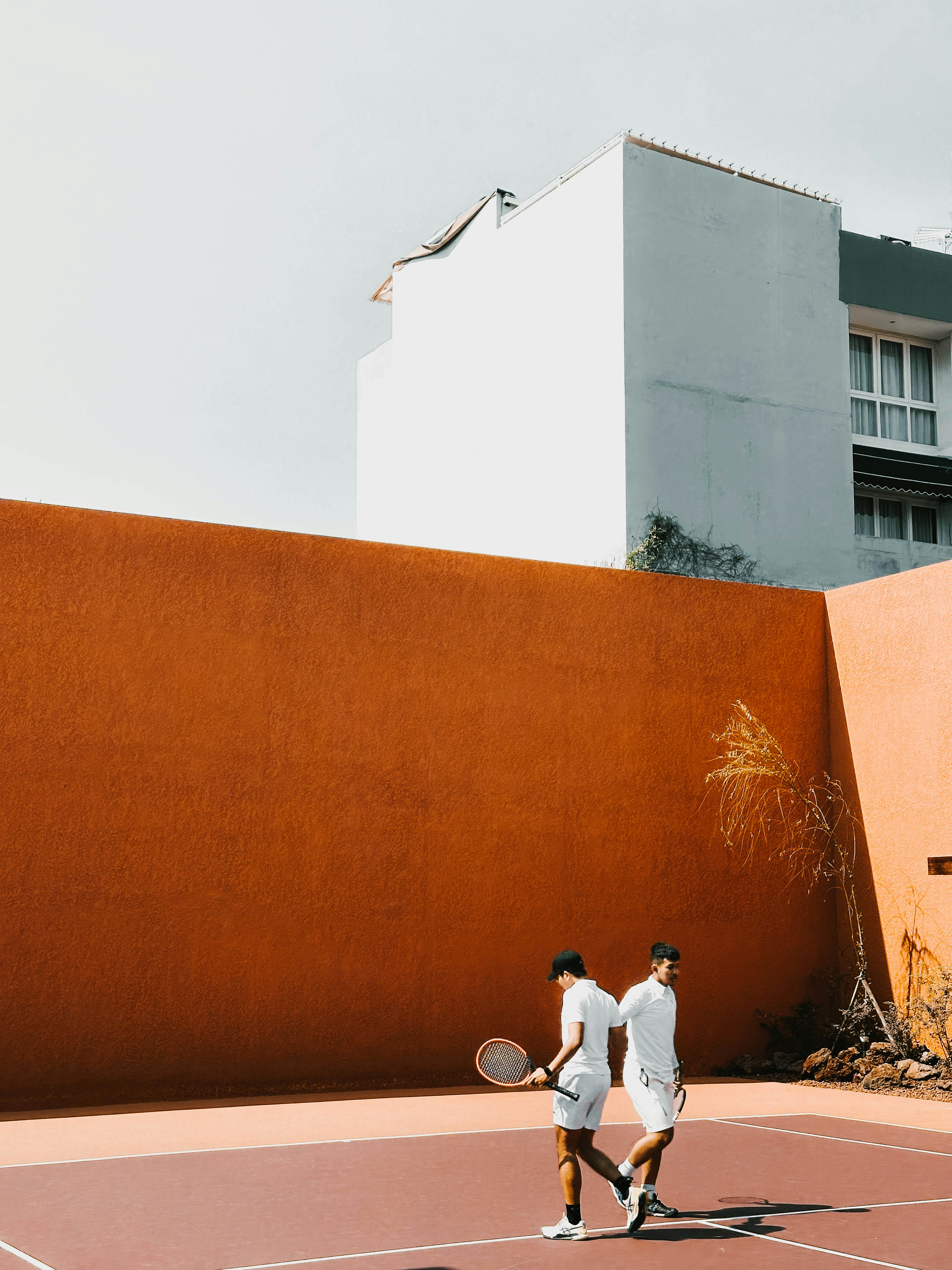 Two men playing tennis on a tennis court photo – Free Common grounds ...